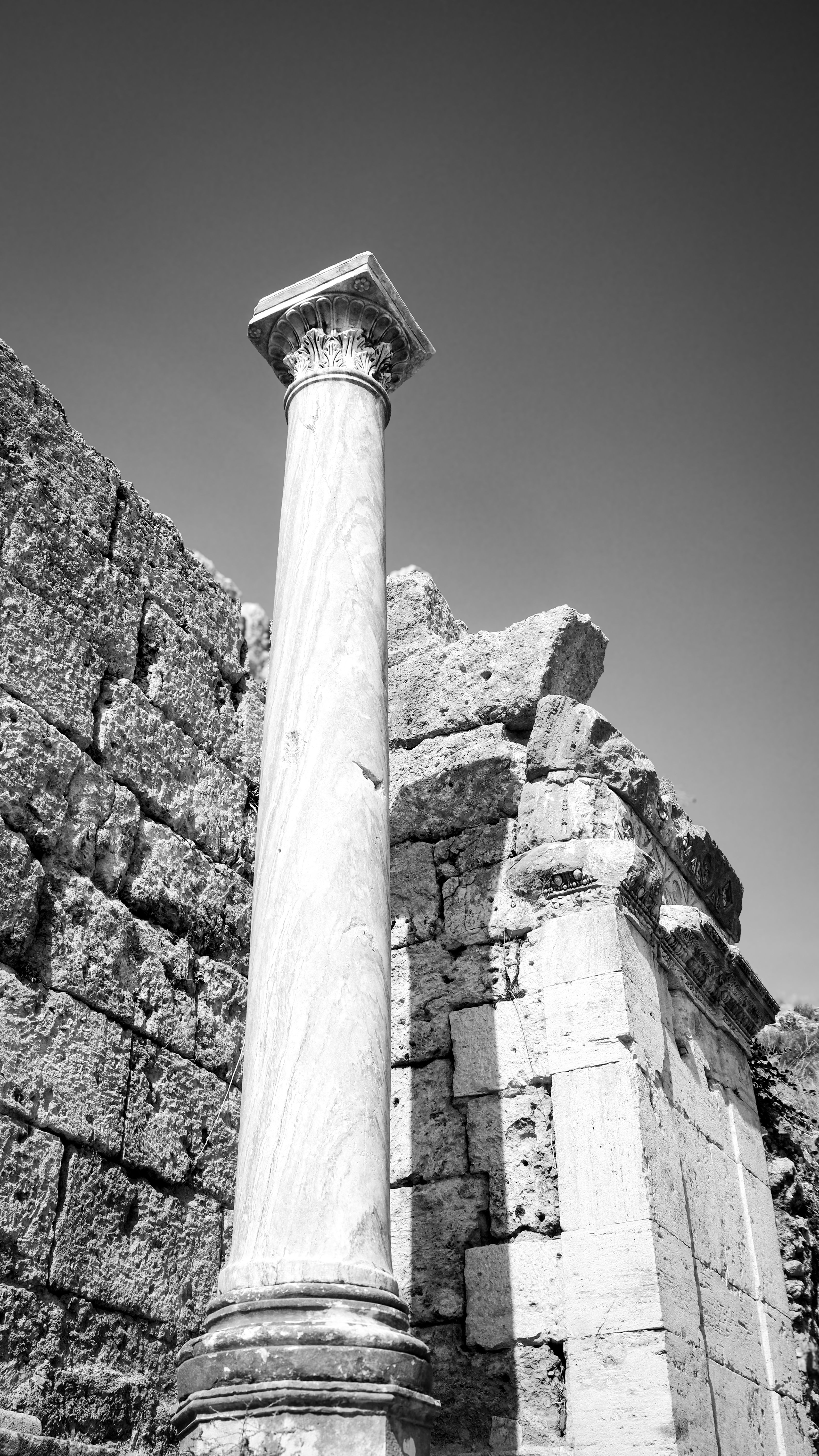 Ancient Roman Column Against Stone Ruins · Free Stock Photo