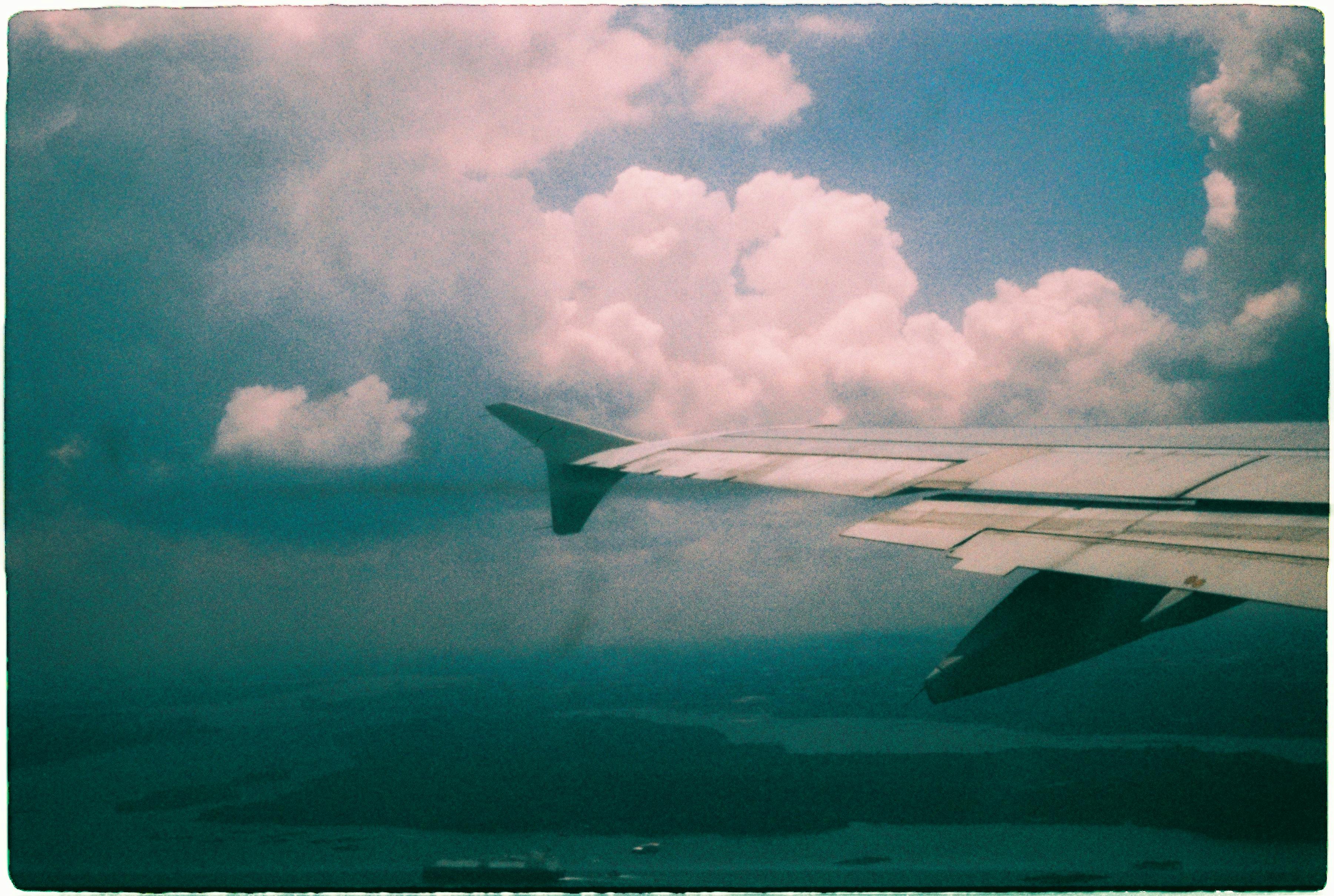 Wing View from Airplane Over Ocean · Free Stock Photo