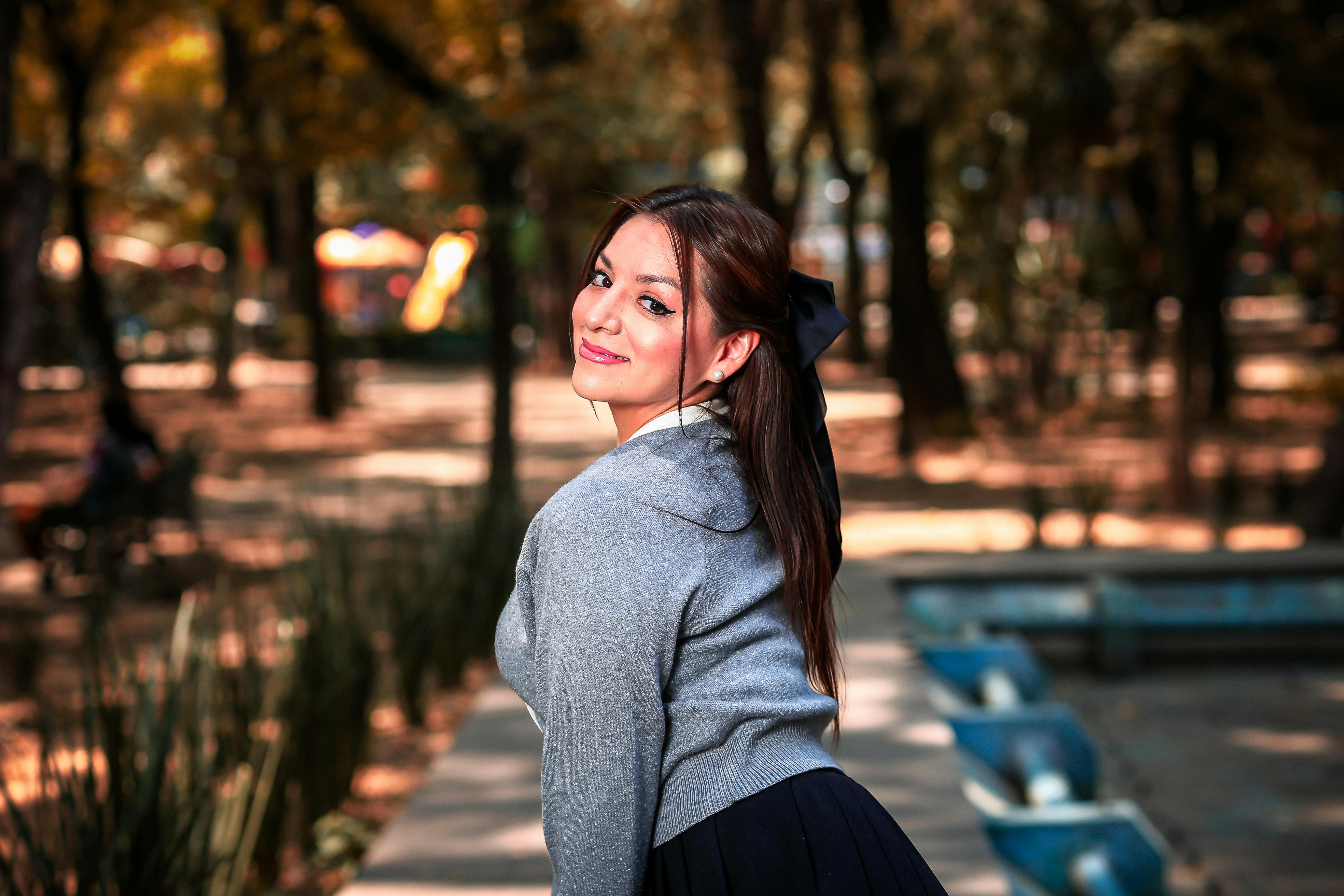 Chic Autumn Fashion in Urban Park Setting · Free Stock Photo