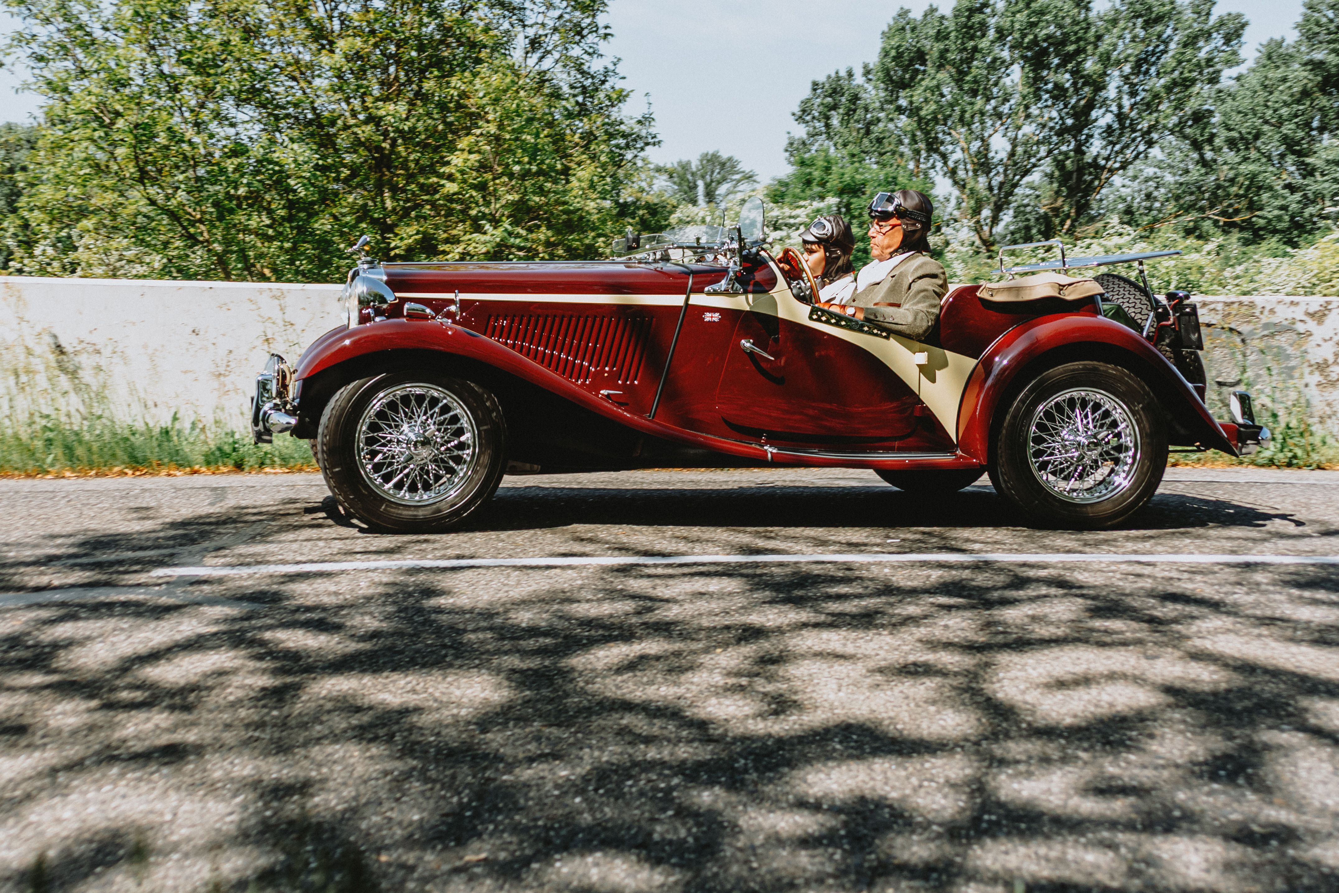 Vintage Car Cruise on Scenic Road · Free Stock Photo
