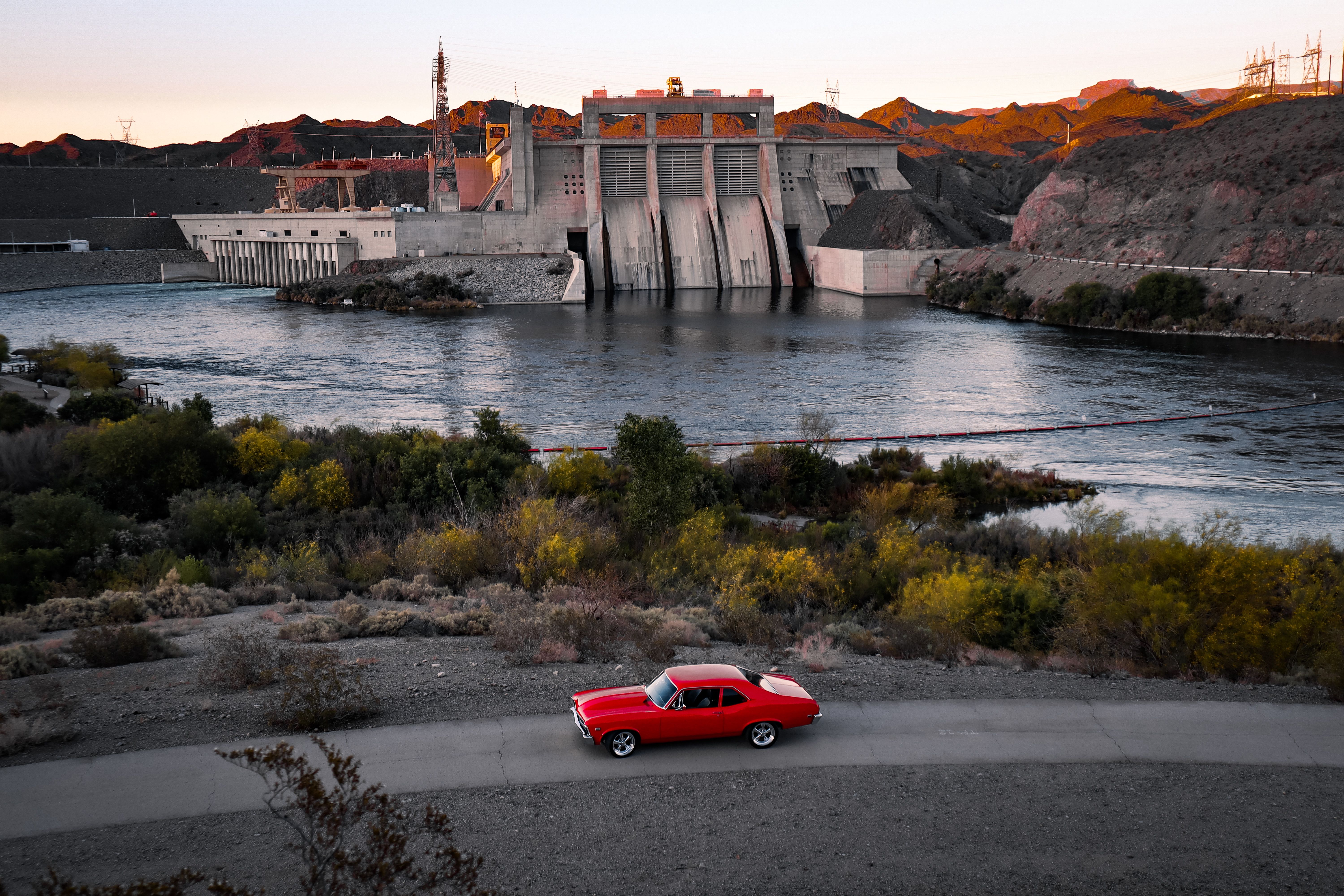 Red Classic Car by Majestic Dam at Sunset · Free Stock Photo