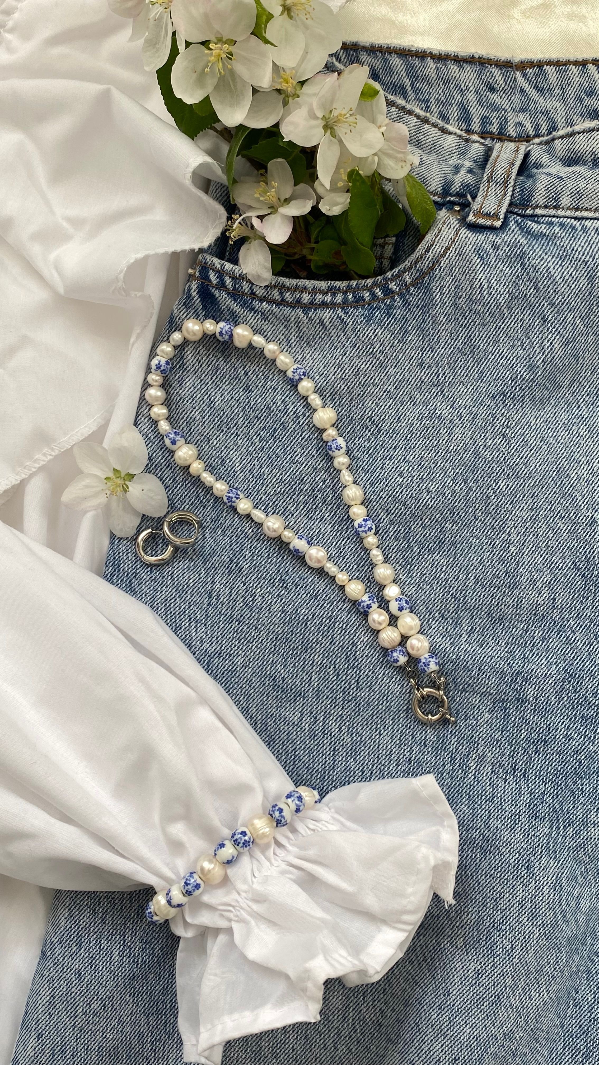 Stylish Denim and Floral Flat Lay with Pearl Jewelry · Free Stock Photo