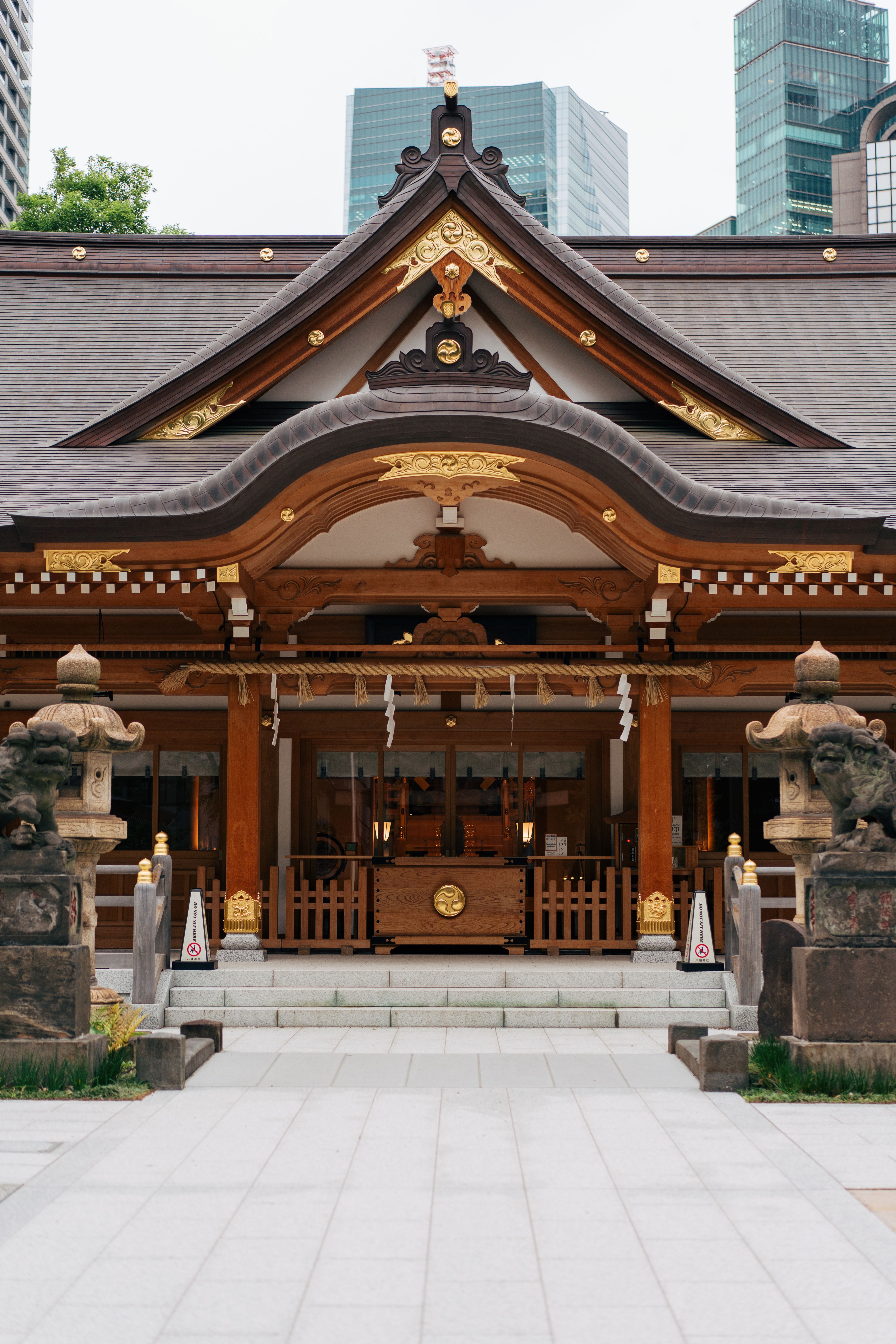 Traditional Japanese Shrine Amidst Urban Skyscrapers · Free Stock Photo