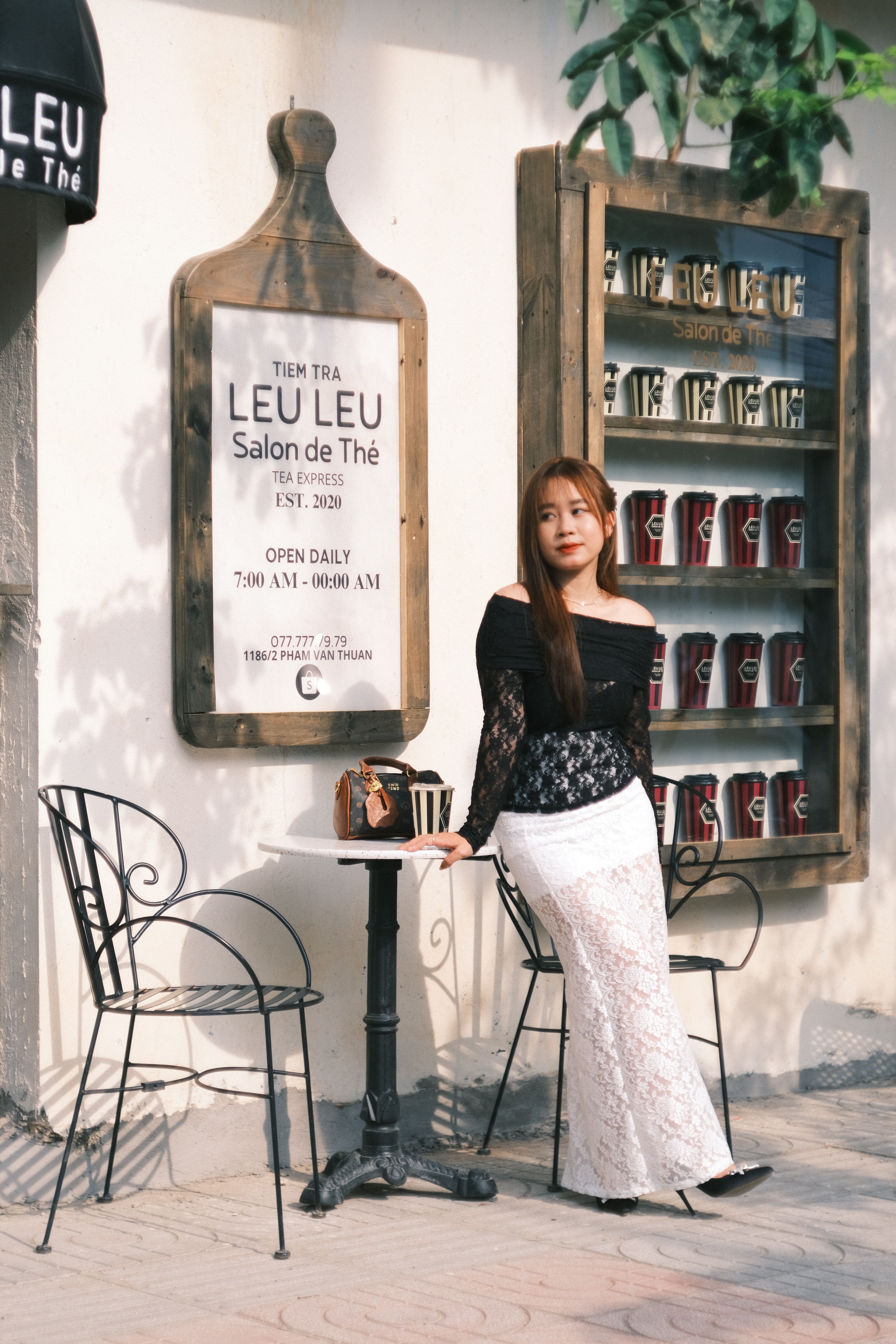 Woman Sitting Outside LEU LEU Tea Salon · Free Stock Photo
