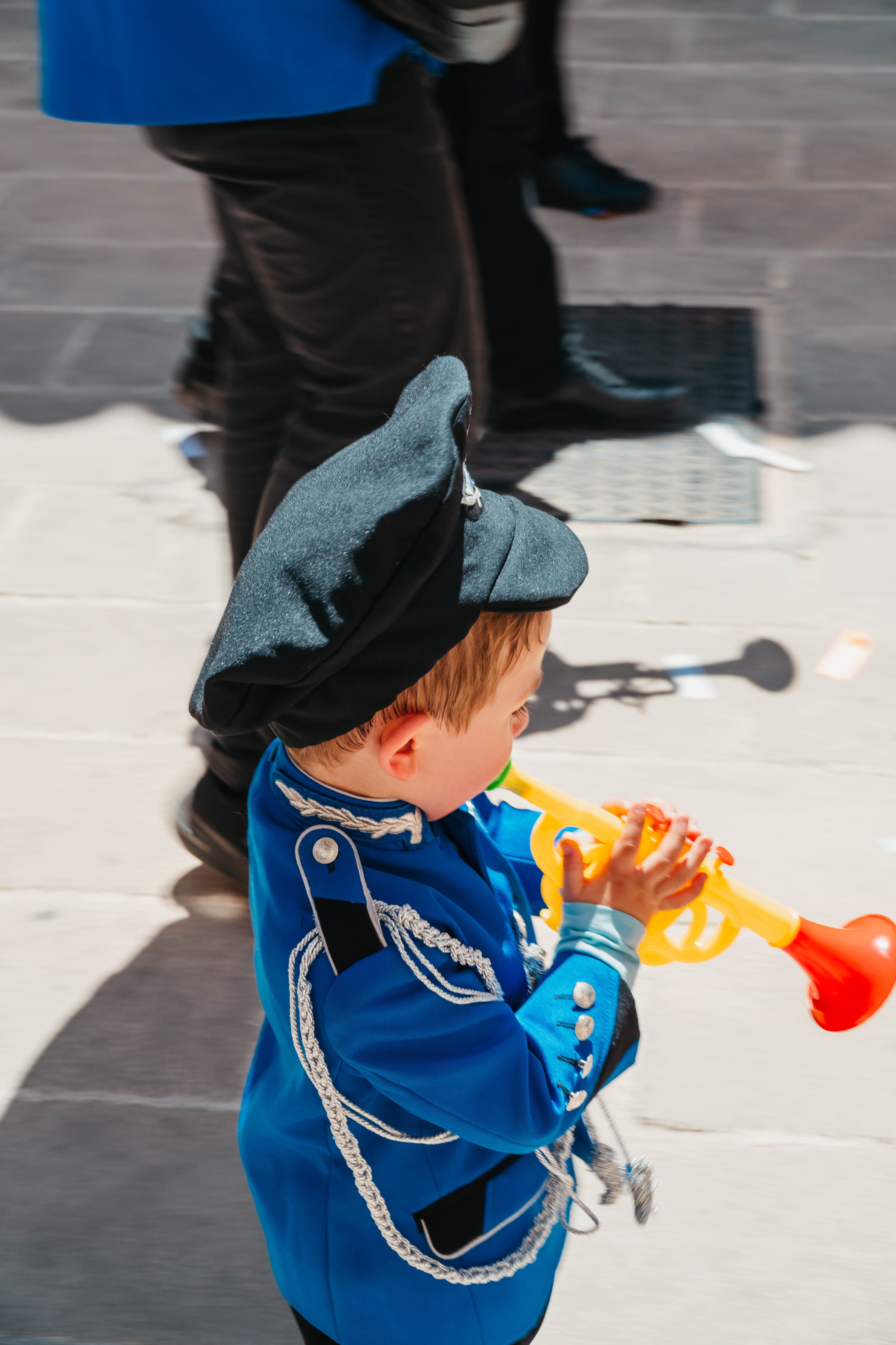 Child in Costume Playing Toy Trumpet Outdoors · Free Stock Photo