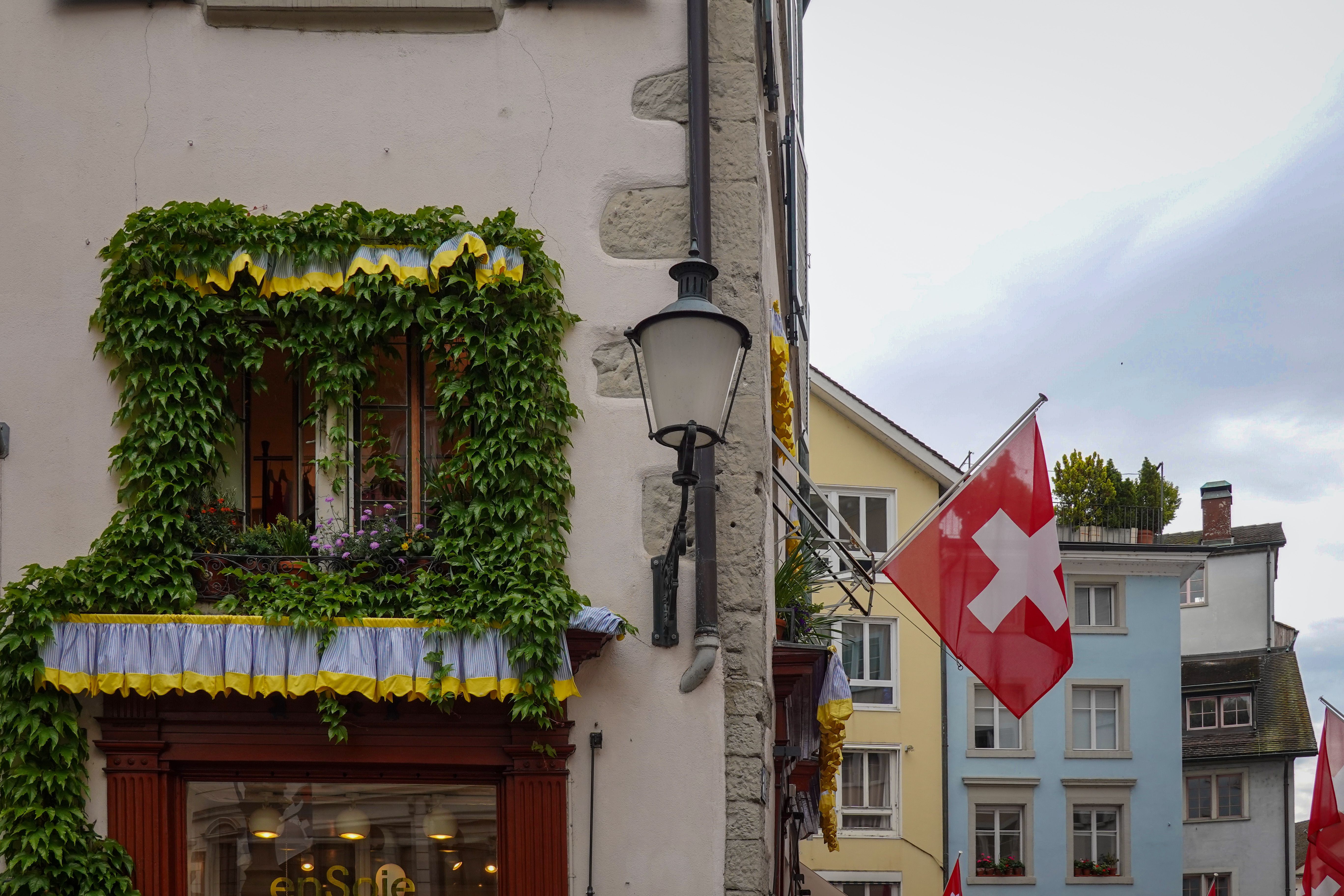 Charming Zurich Street With Swiss Flag Displayed · Free Stock Photo