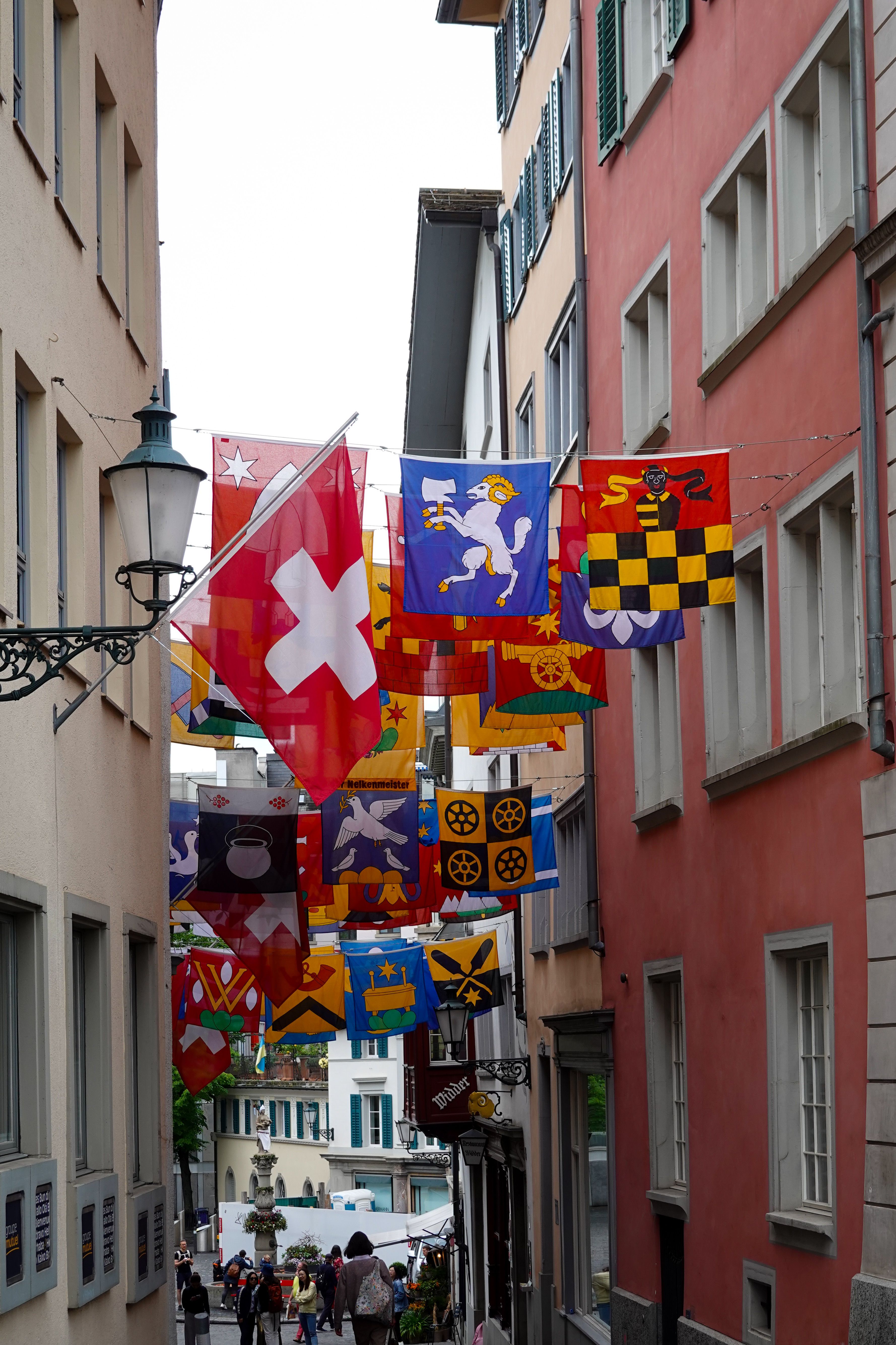 Colorful Flags in a Zurich Old Town Alleyway · Free Stock Photo