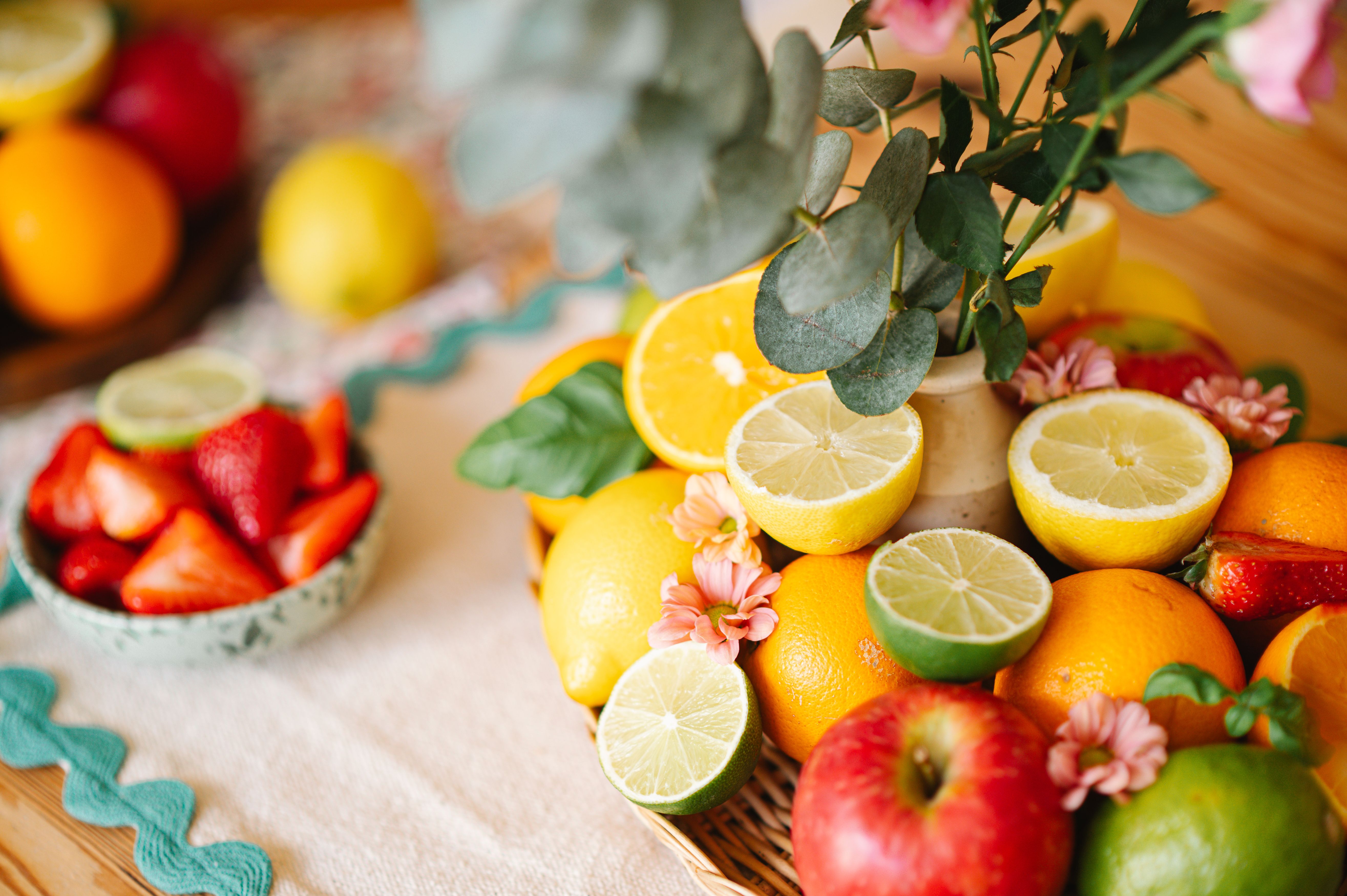 Colorful Fruit Arrangement with Citrus and Flowers · Free Stock Photo