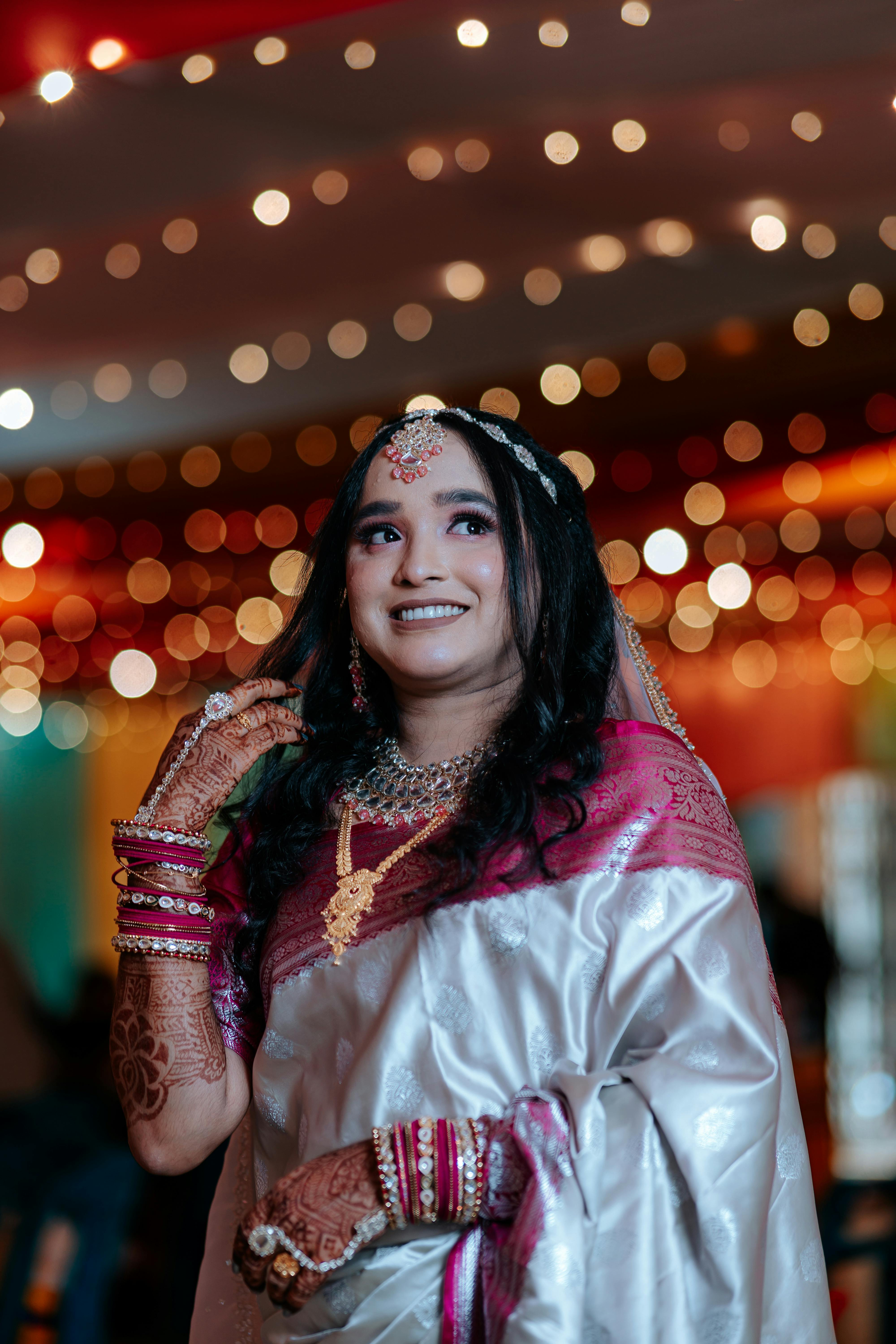 Bride in Traditional Attire with Henna at Festive Event · Free Stock Photo