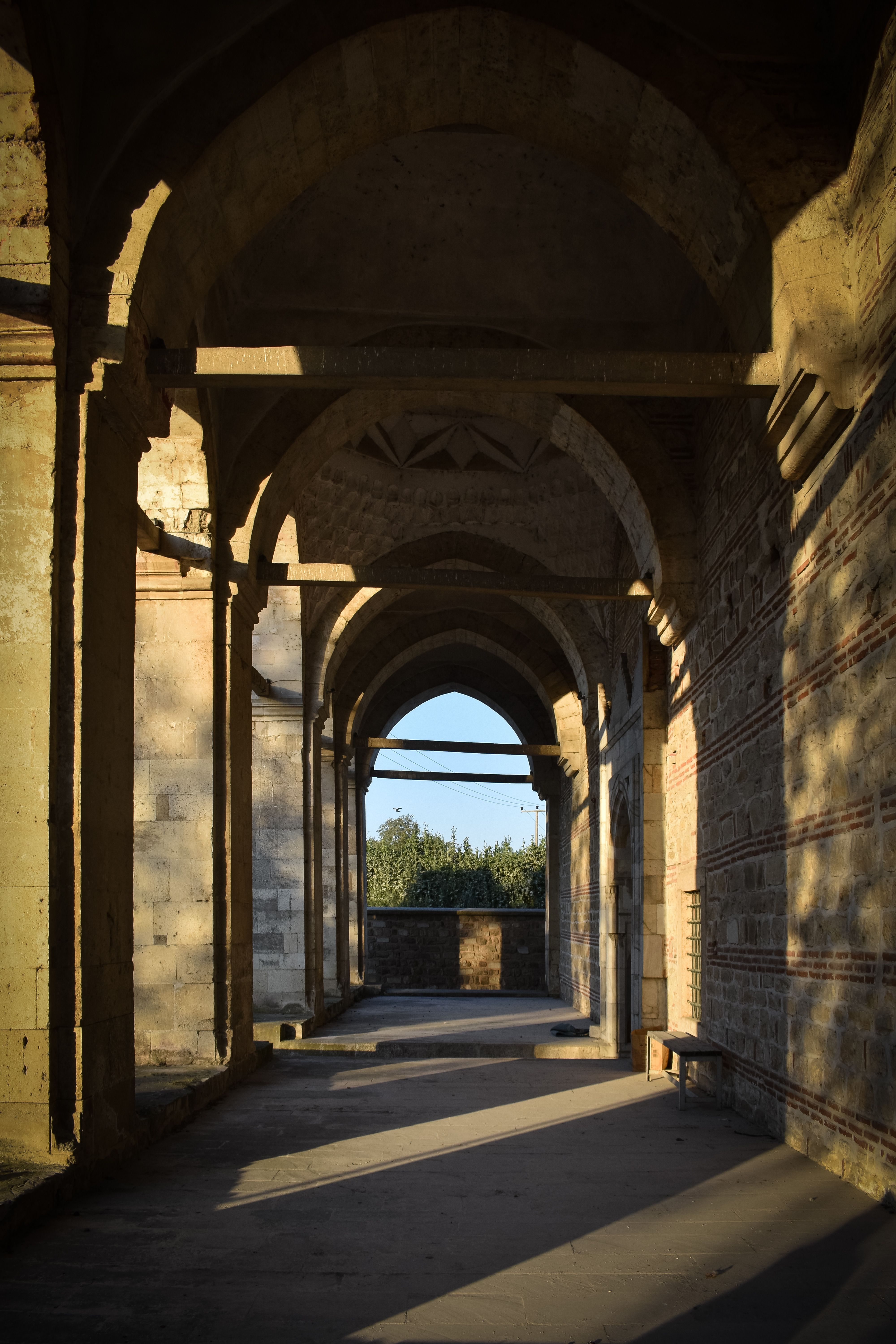 Historic Stone Arch Corridor with Sunlight · Free Stock Photo