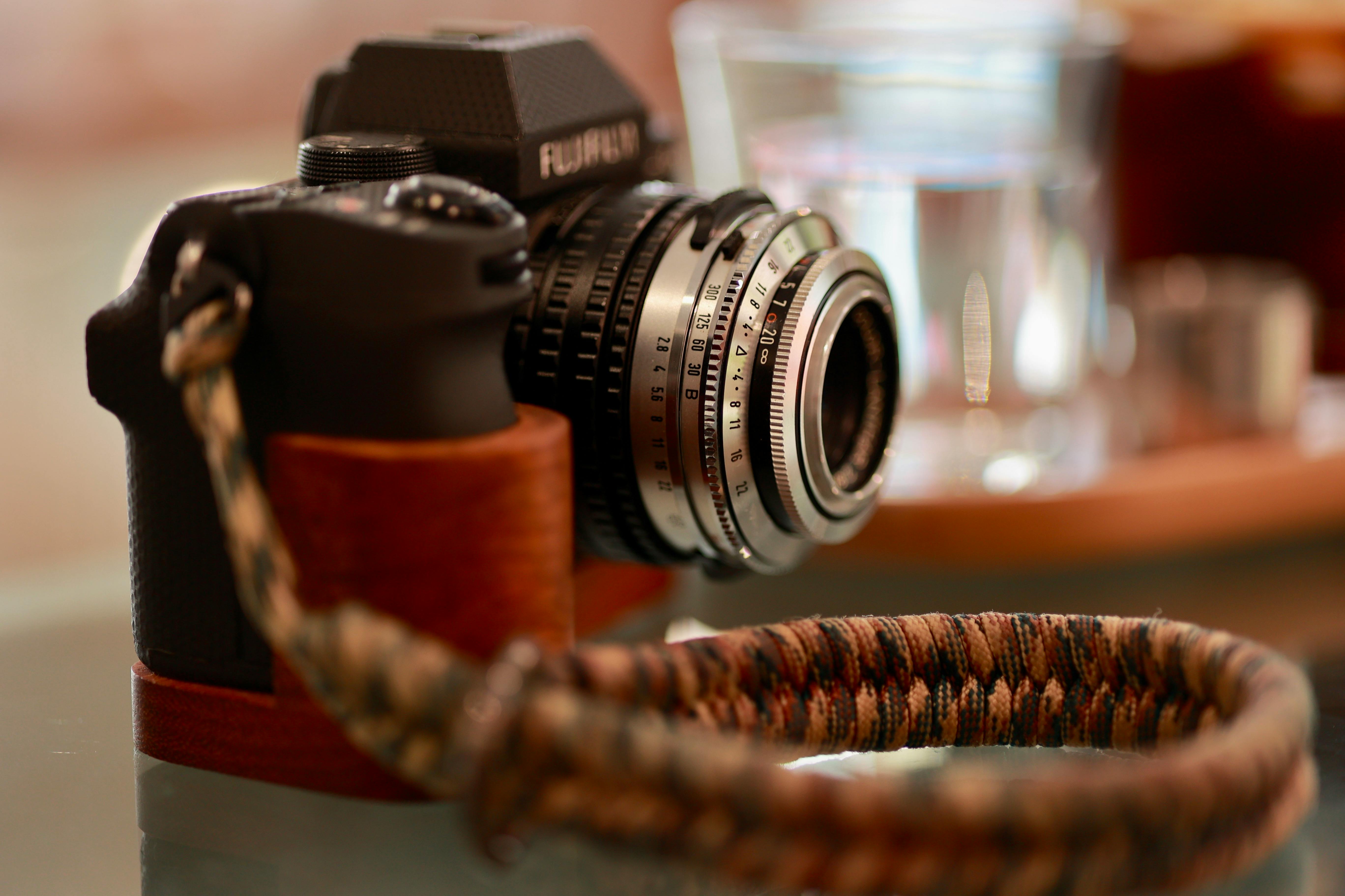 Vintage Camera with Lens on Table Indoors · Free Stock Photo