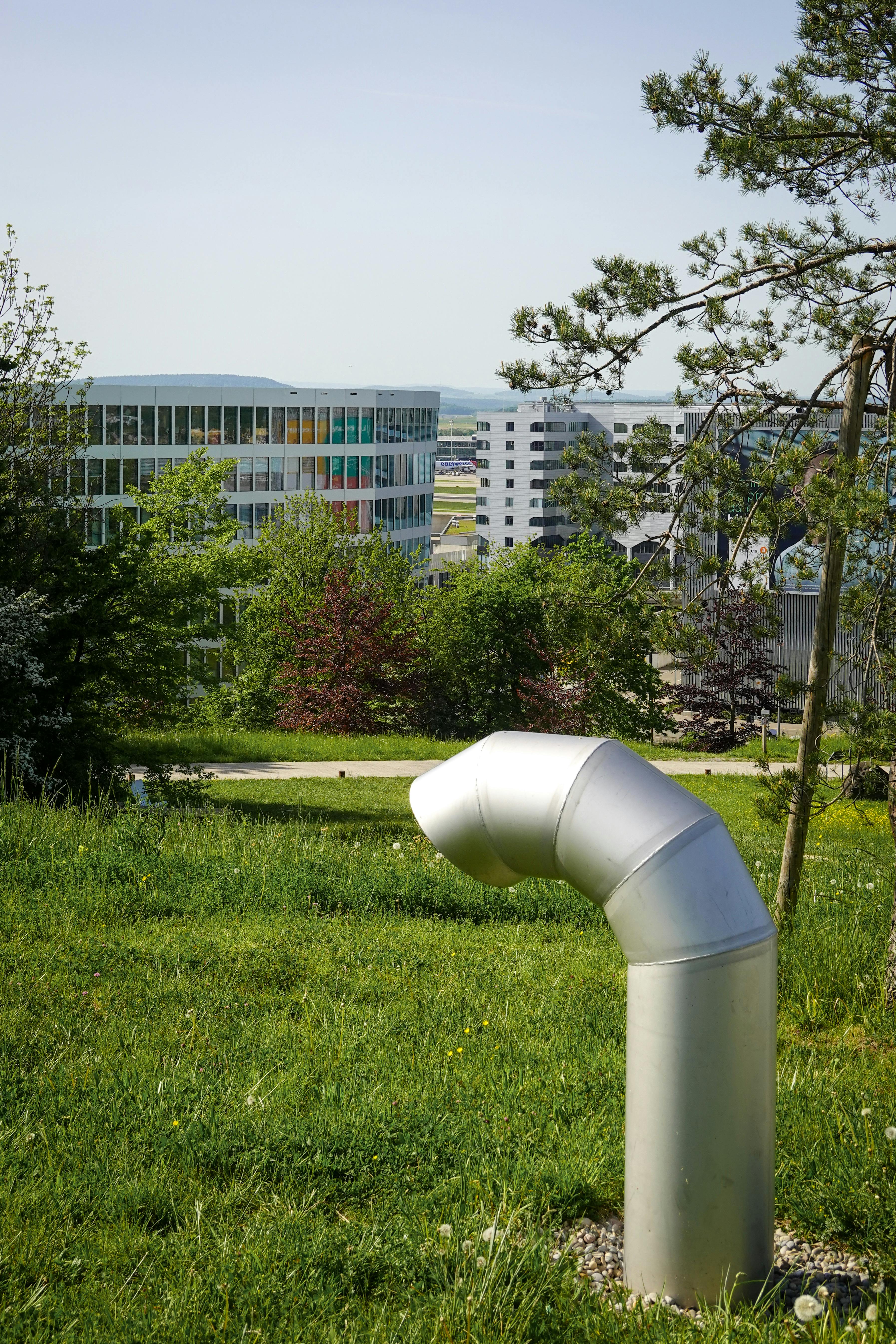 Modern Architecture with Industrial Pipe in Green Landscape · Free ...