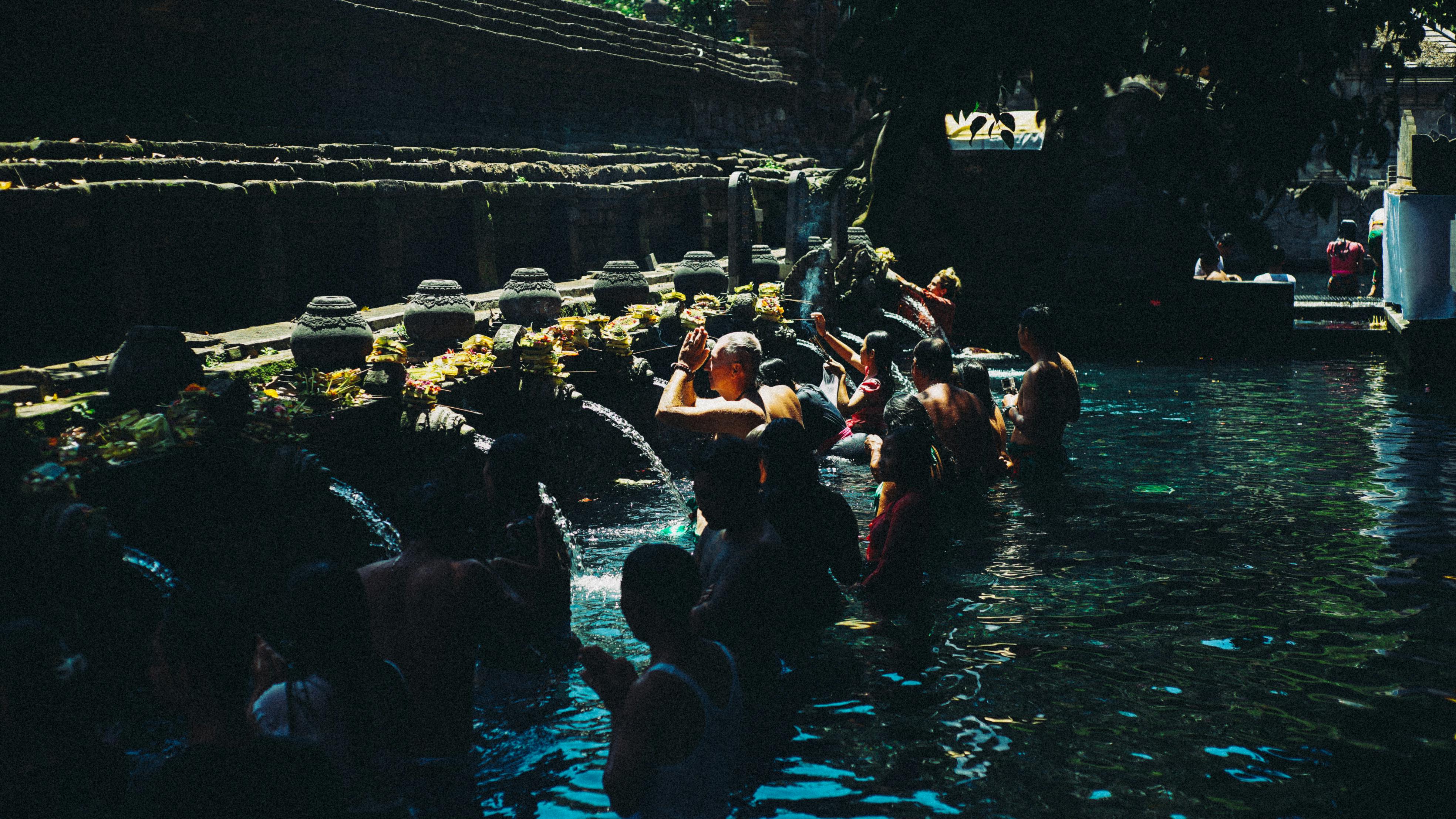 People Performing Ritual Bathing in Sacred Temple Pool · Free Stock Photo