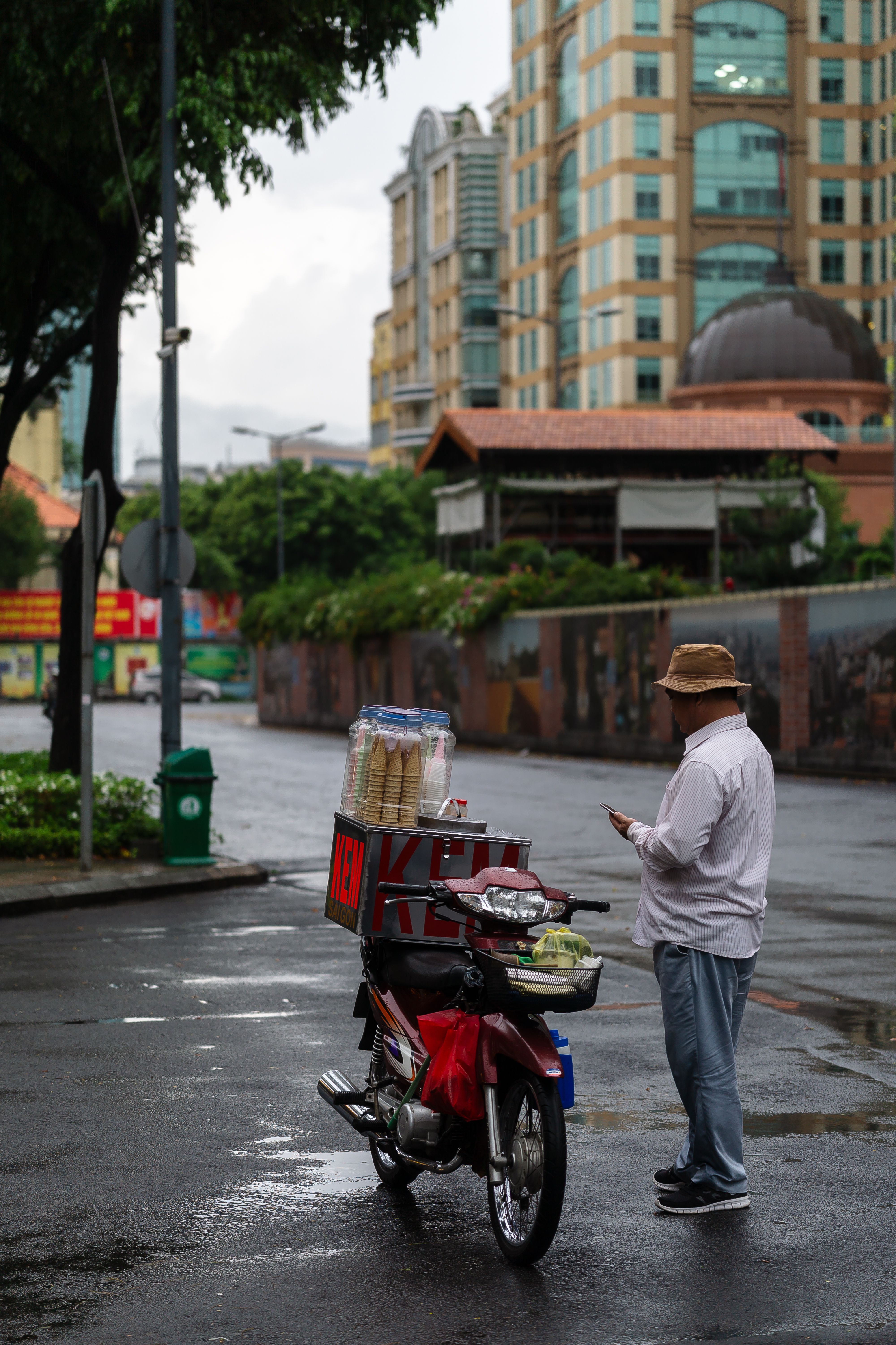 Street Vendor with Motorcycle in Urban Setting · Free Stock Photo