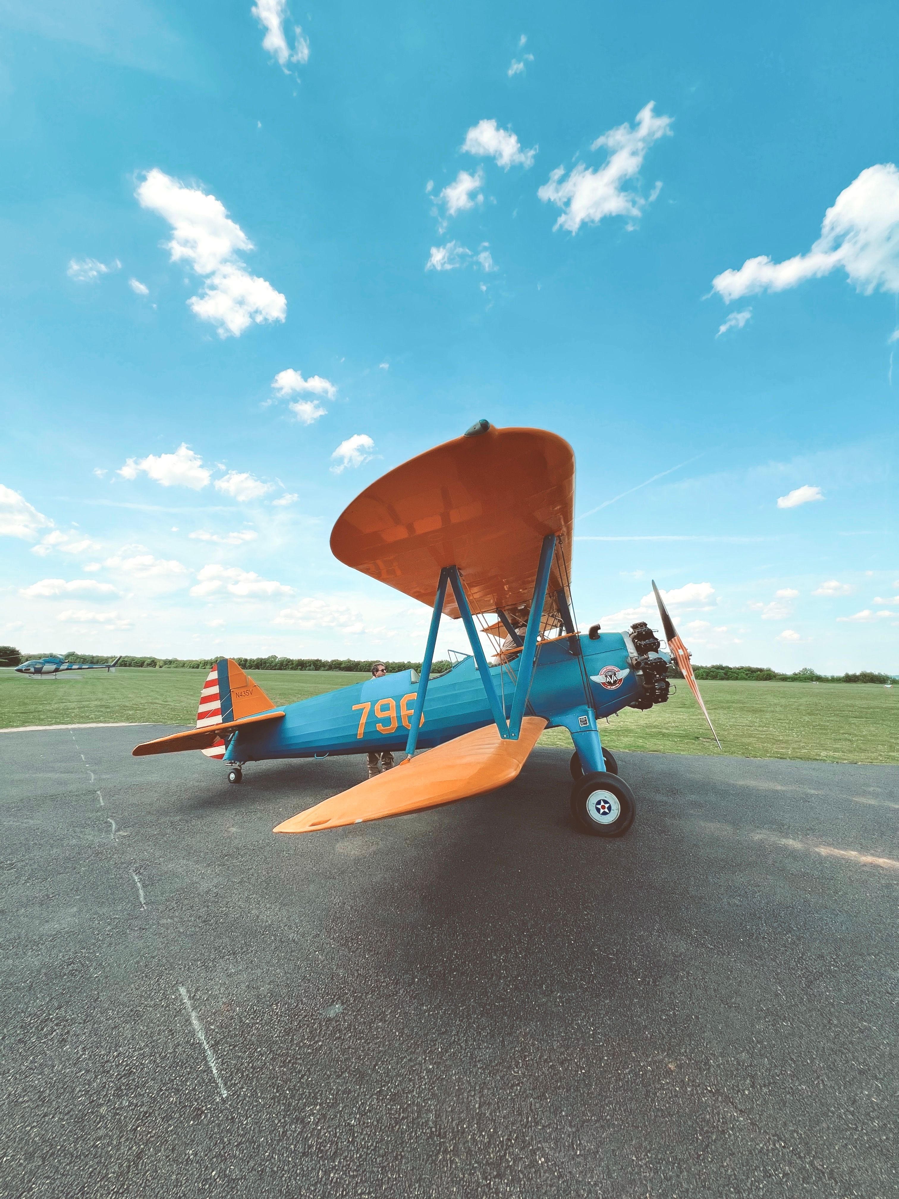 Vintage Biplane on Sunny Day at Airstrip · Free Stock Photo