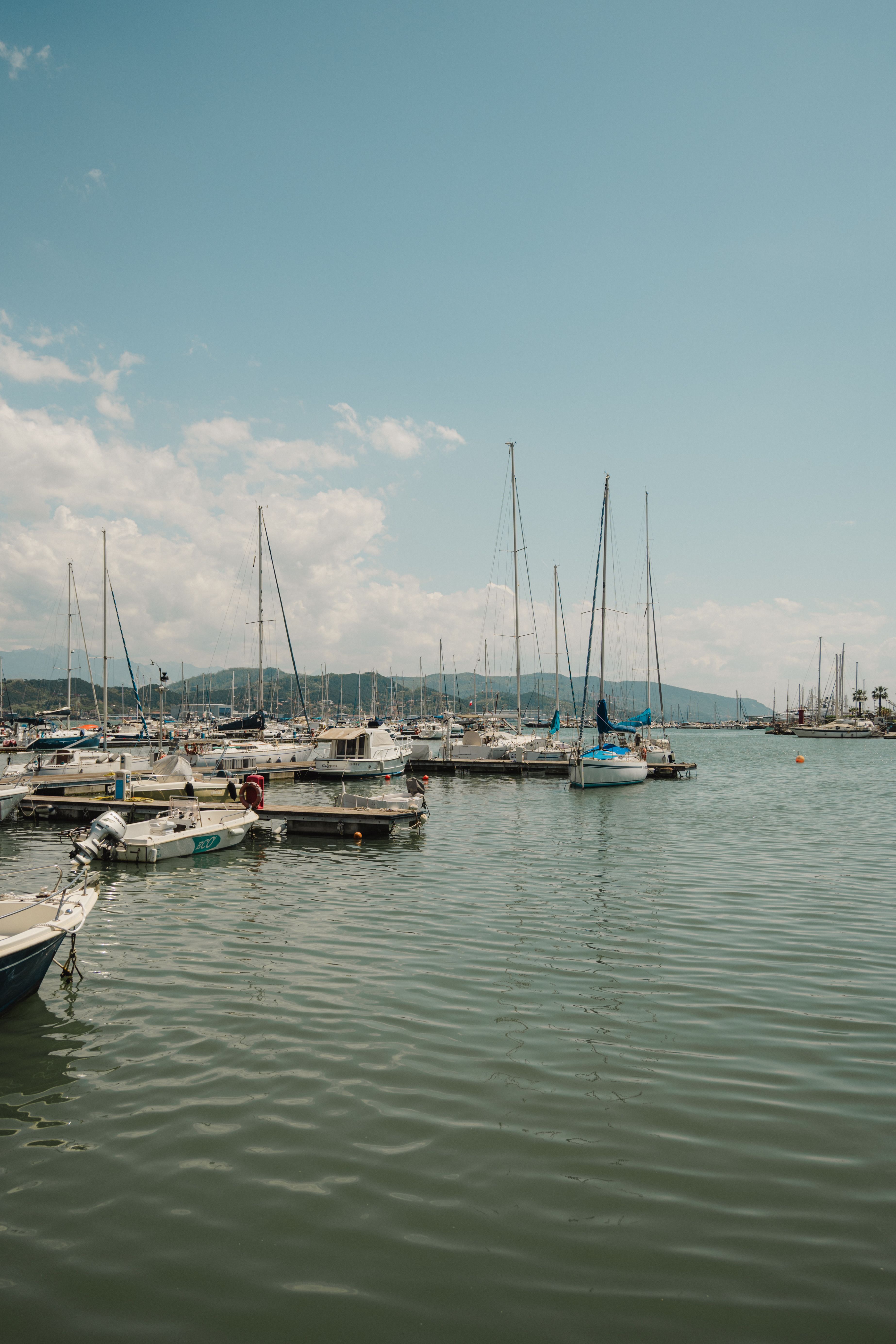 Serene Marina Landscape with Boats and Mountains · Free Stock Photo