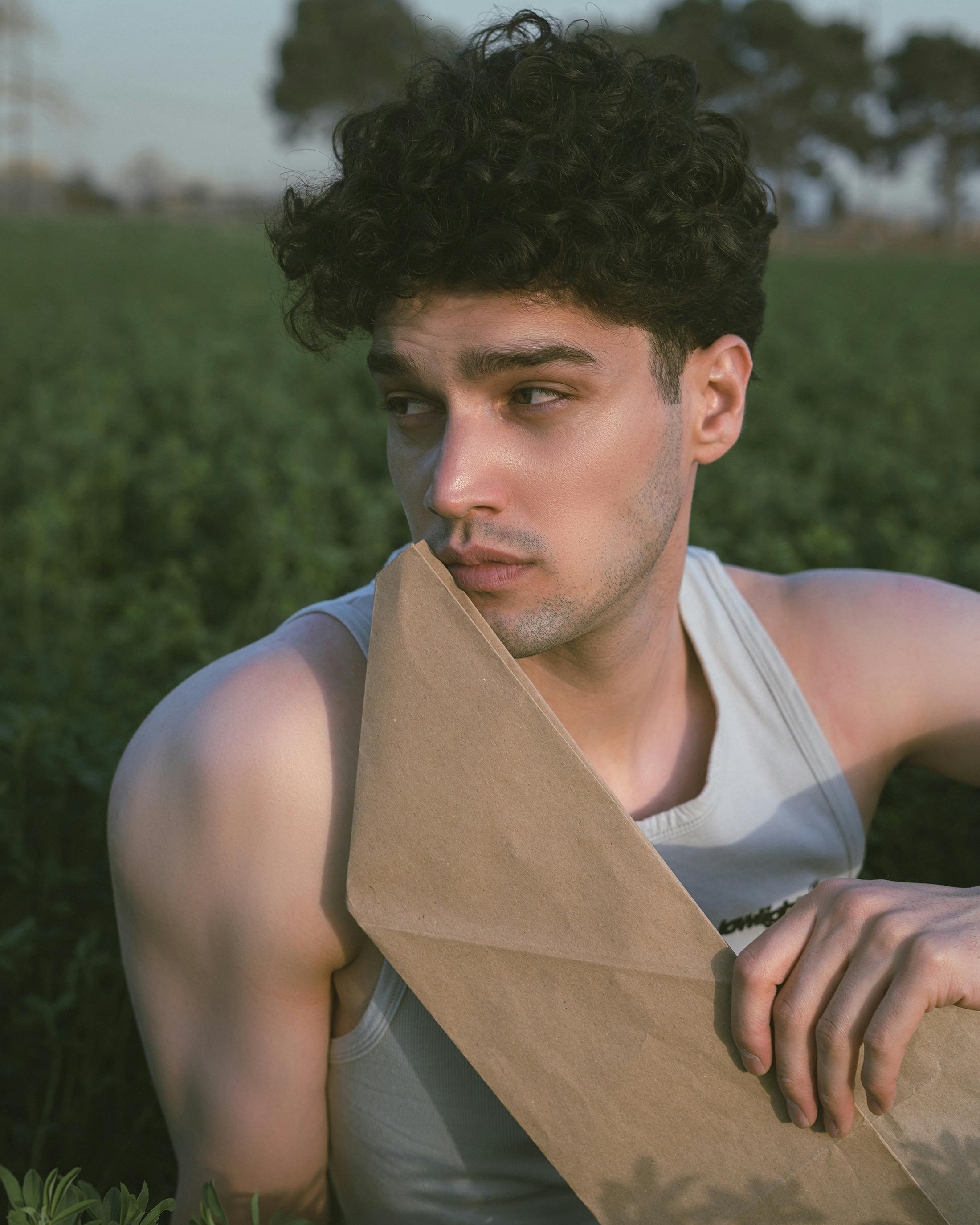 Contemplative Man Holding Paper Outdoors · Free Stock Photo