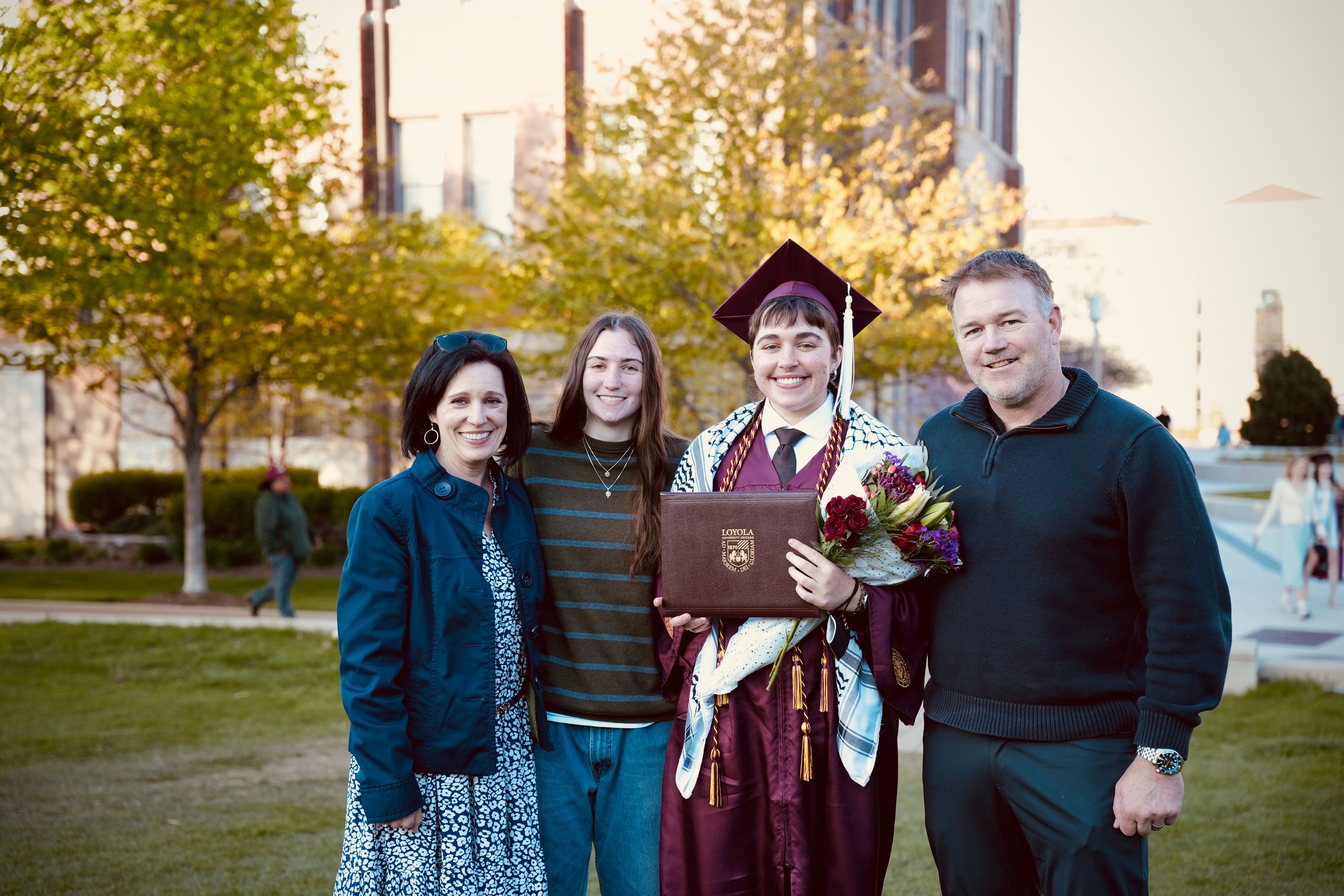 Happy Graduate Celebrating with Family Outdoors · Free Stock Photo