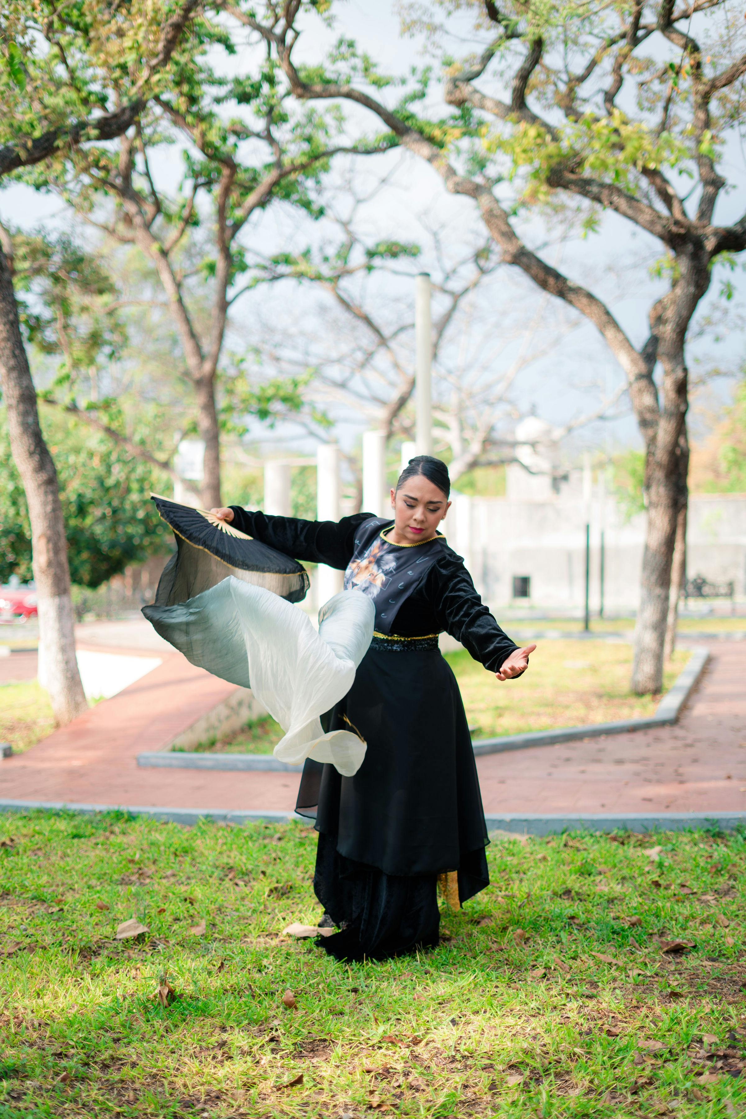 Elegant Woman Dancing in Outdoor Park Setting · Free Stock Photo