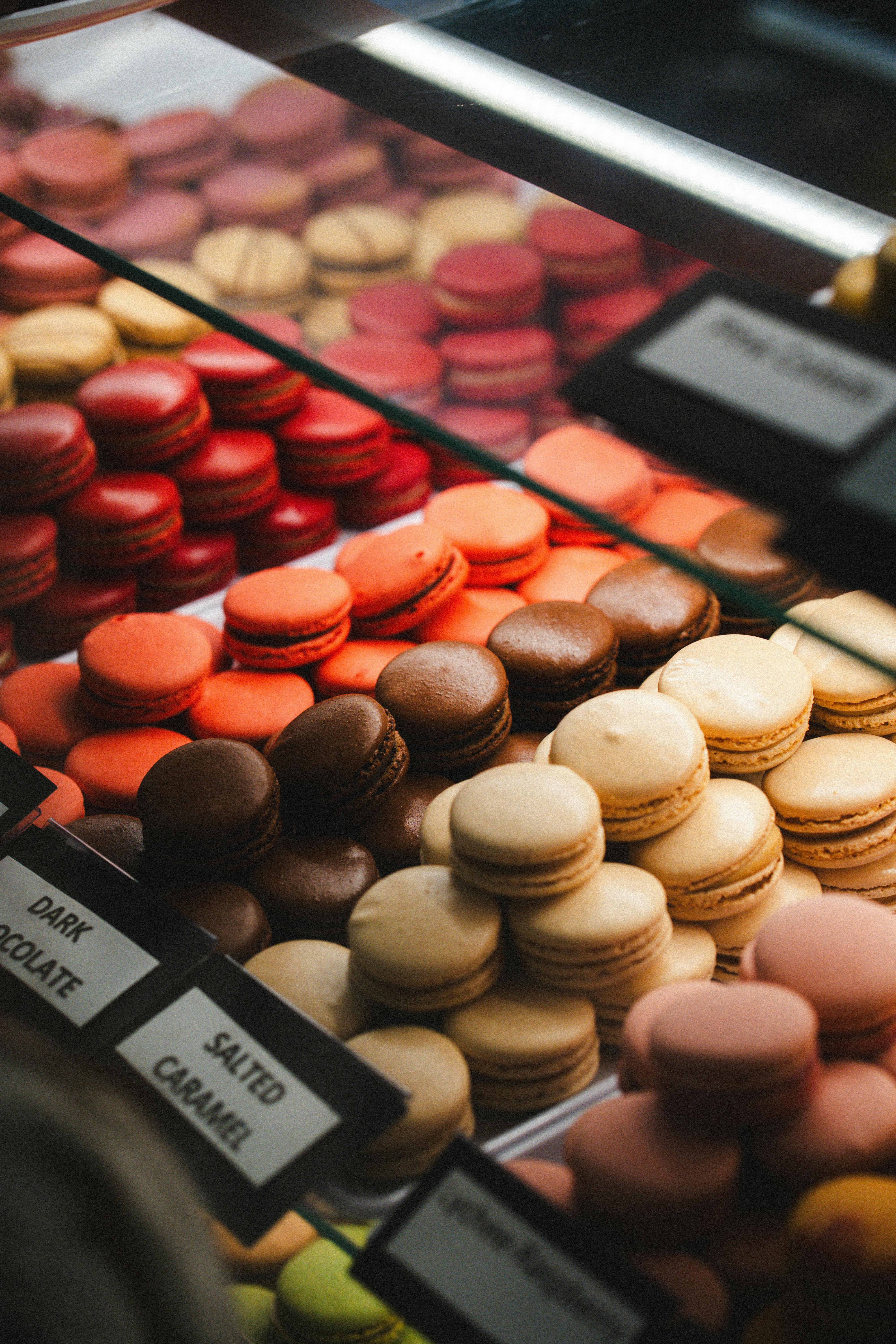 Vibrant Display of Assorted French Macarons in Bakery · Free Stock Photo