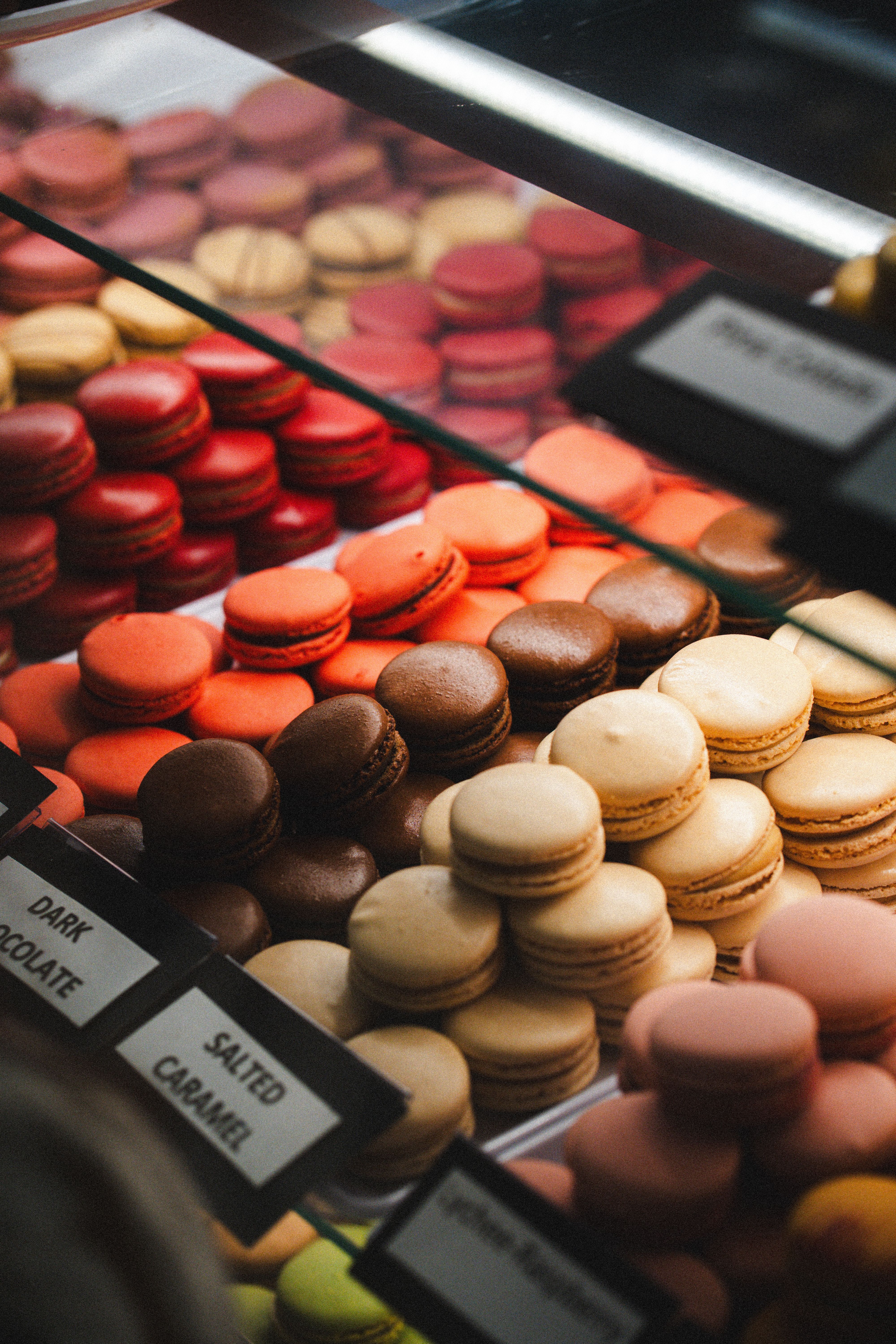 Vibrant Display of Assorted French Macarons in Bakery · Free Stock Photo