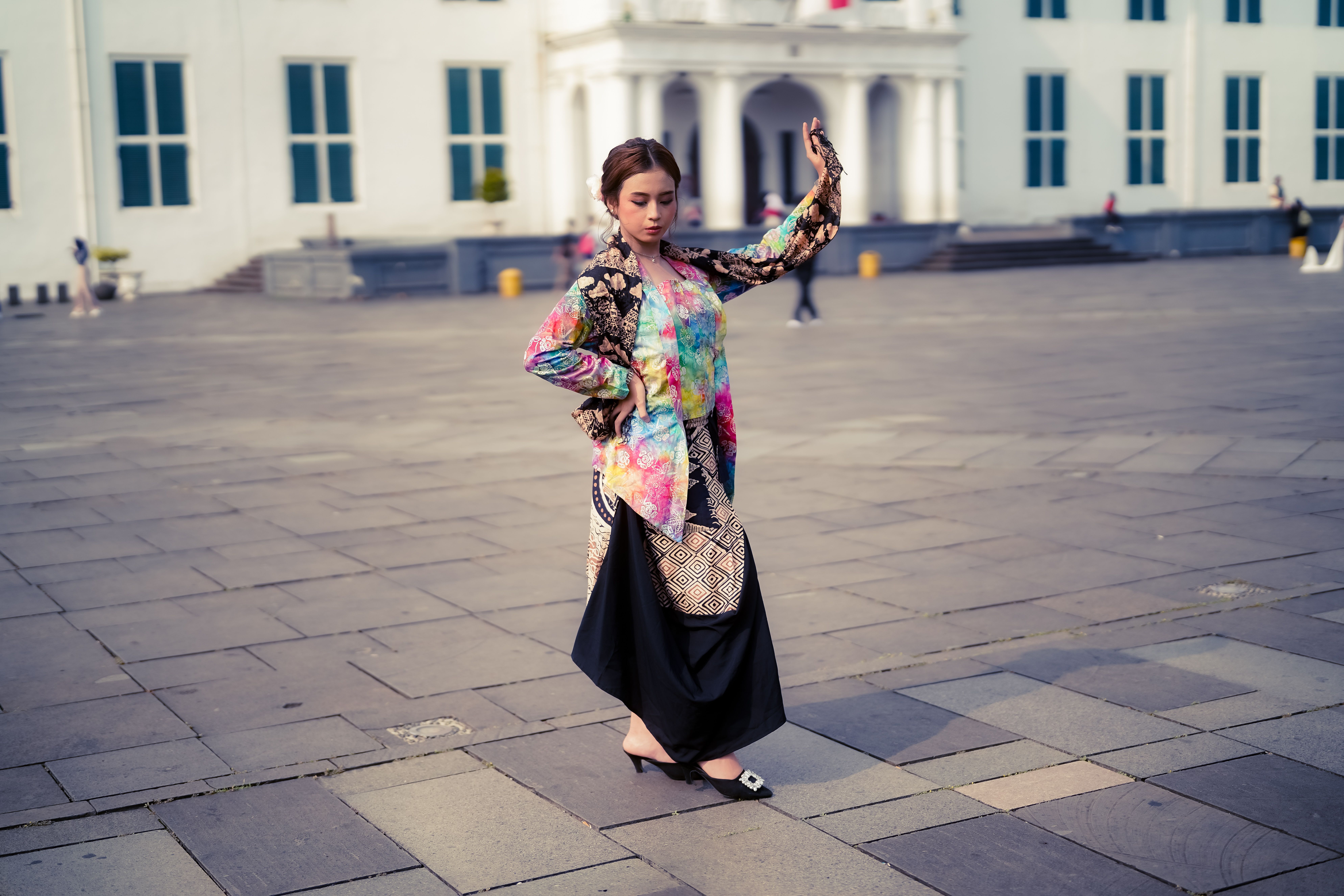 Woman Dancing in Traditional Batik Attire Outdoors · Free Stock Photo