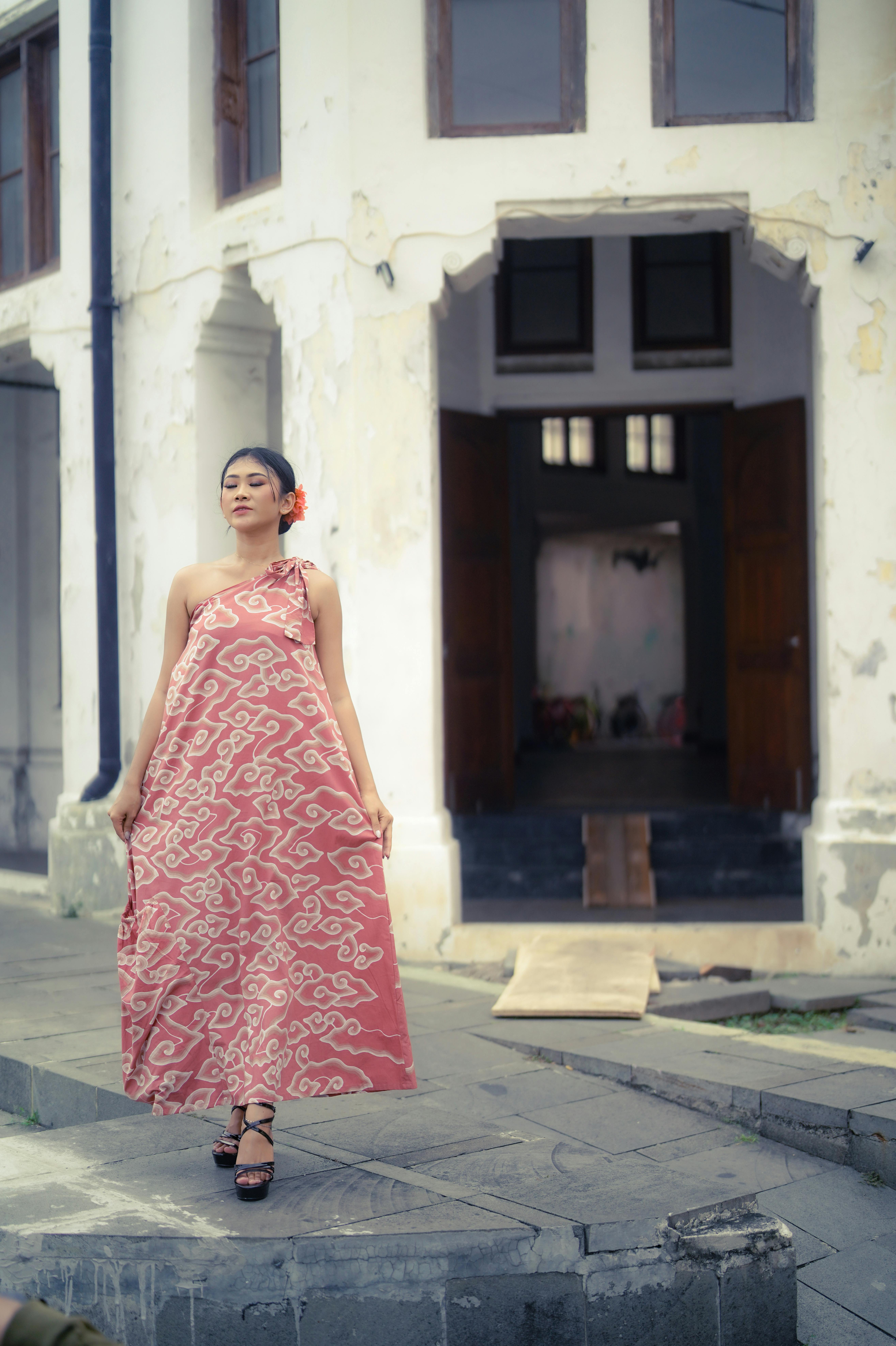 Elegant Woman in Red Batik Dress Outdoors · Free Stock Photo