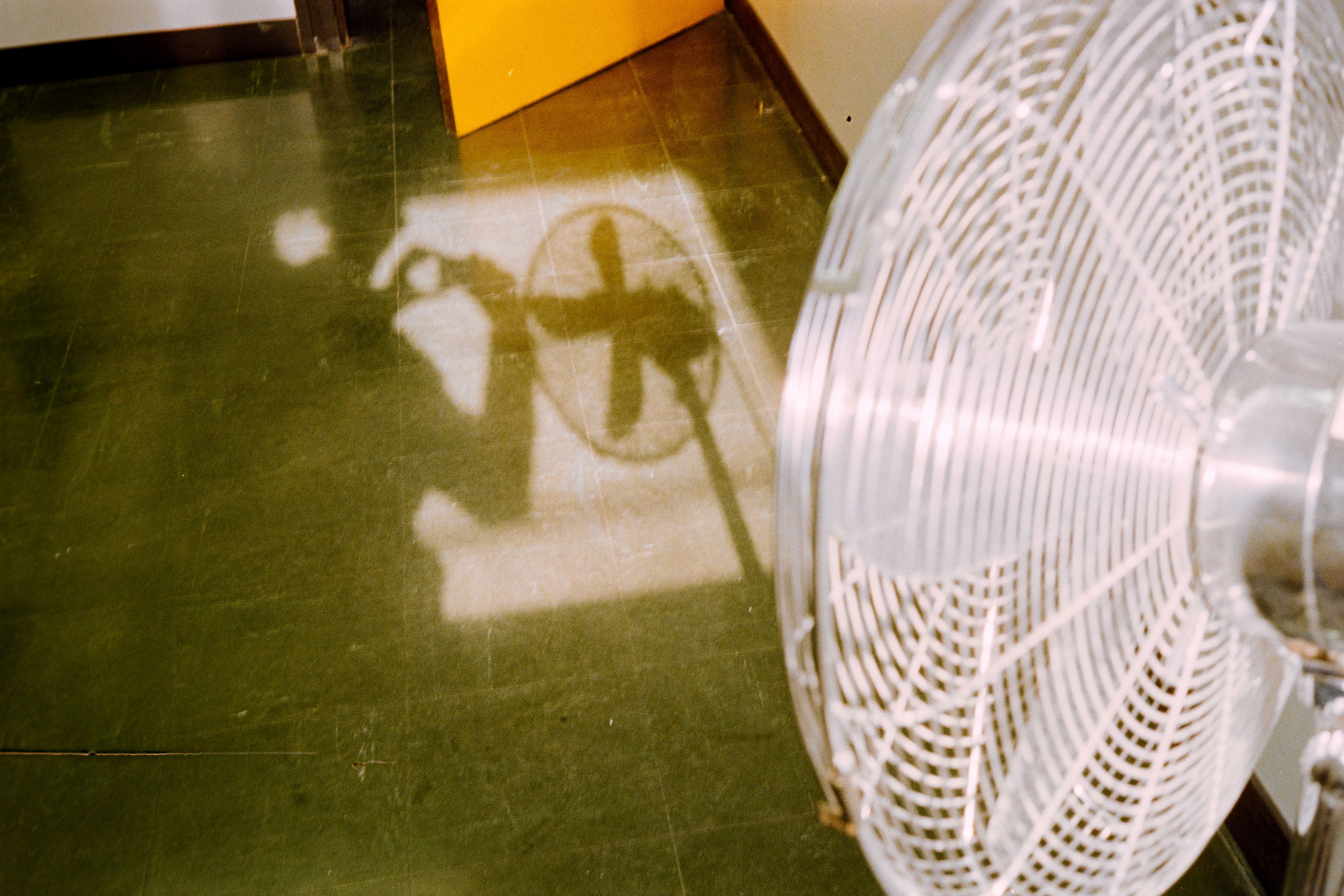 Creative Shadow of Fan on Green Floor · Free Stock Photo