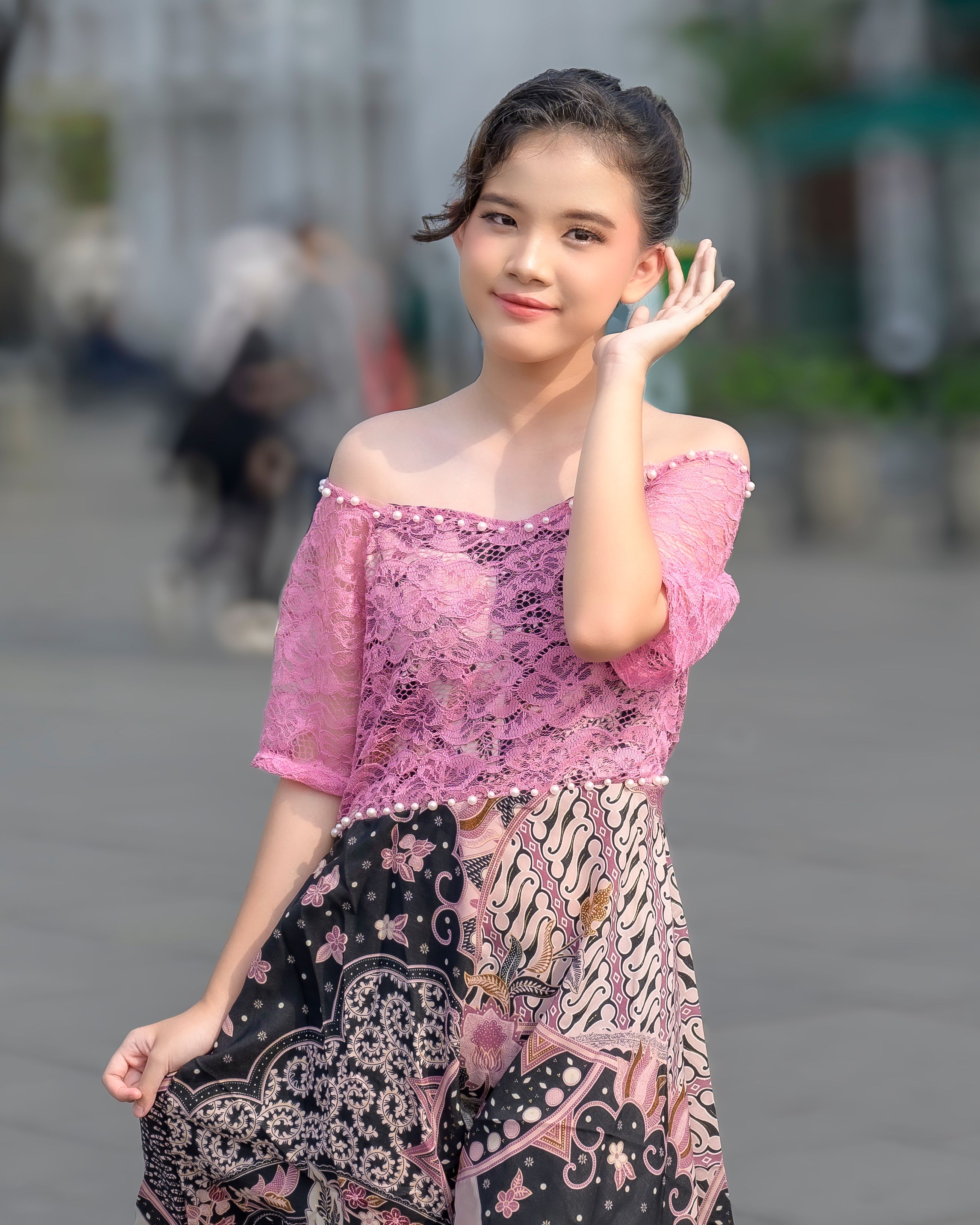 Young Girl Posing in Traditional Batik Dress Outdoors · Free Stock Photo