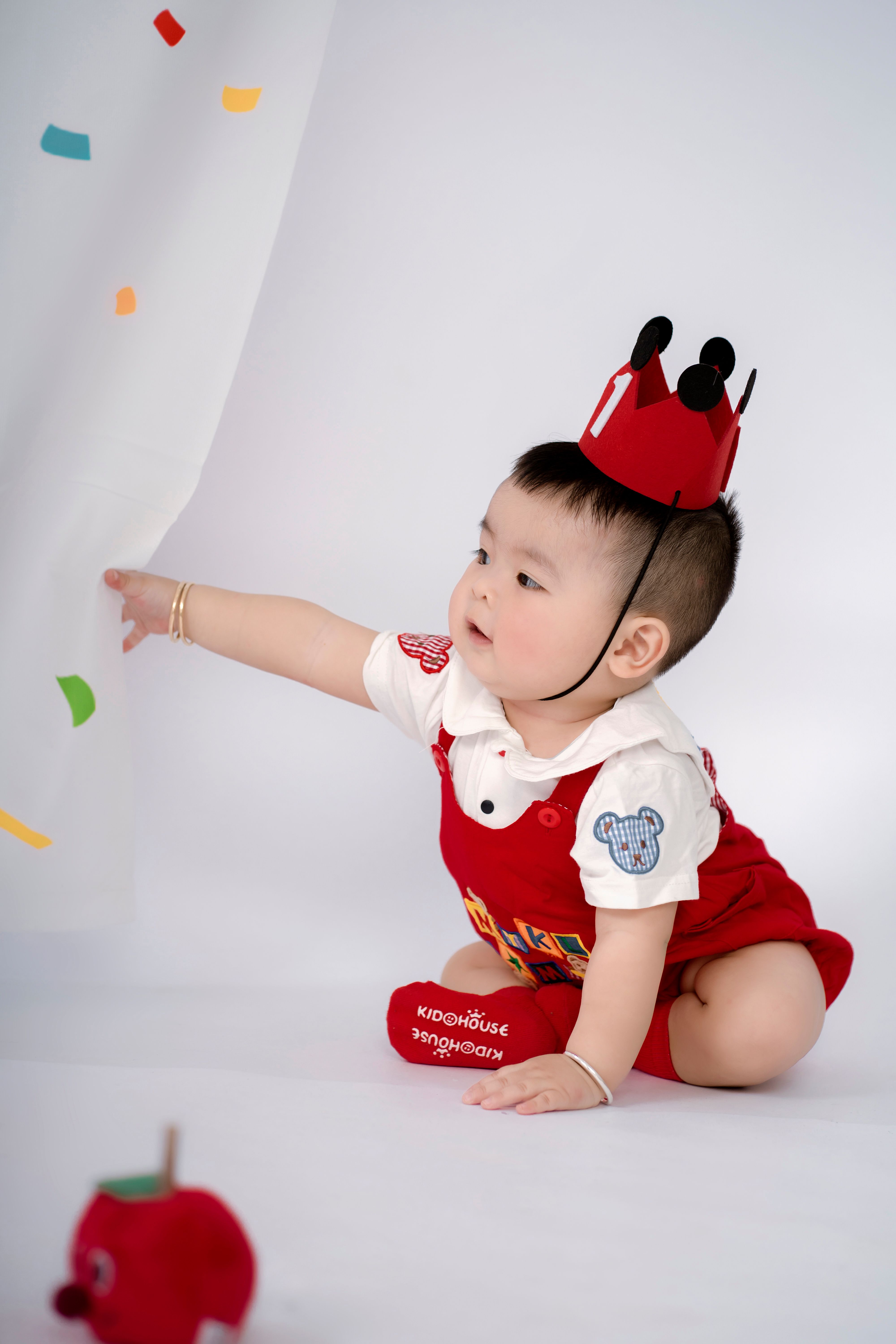Adorable Baby in Red Outfits Reaching Out · Free Stock Photo