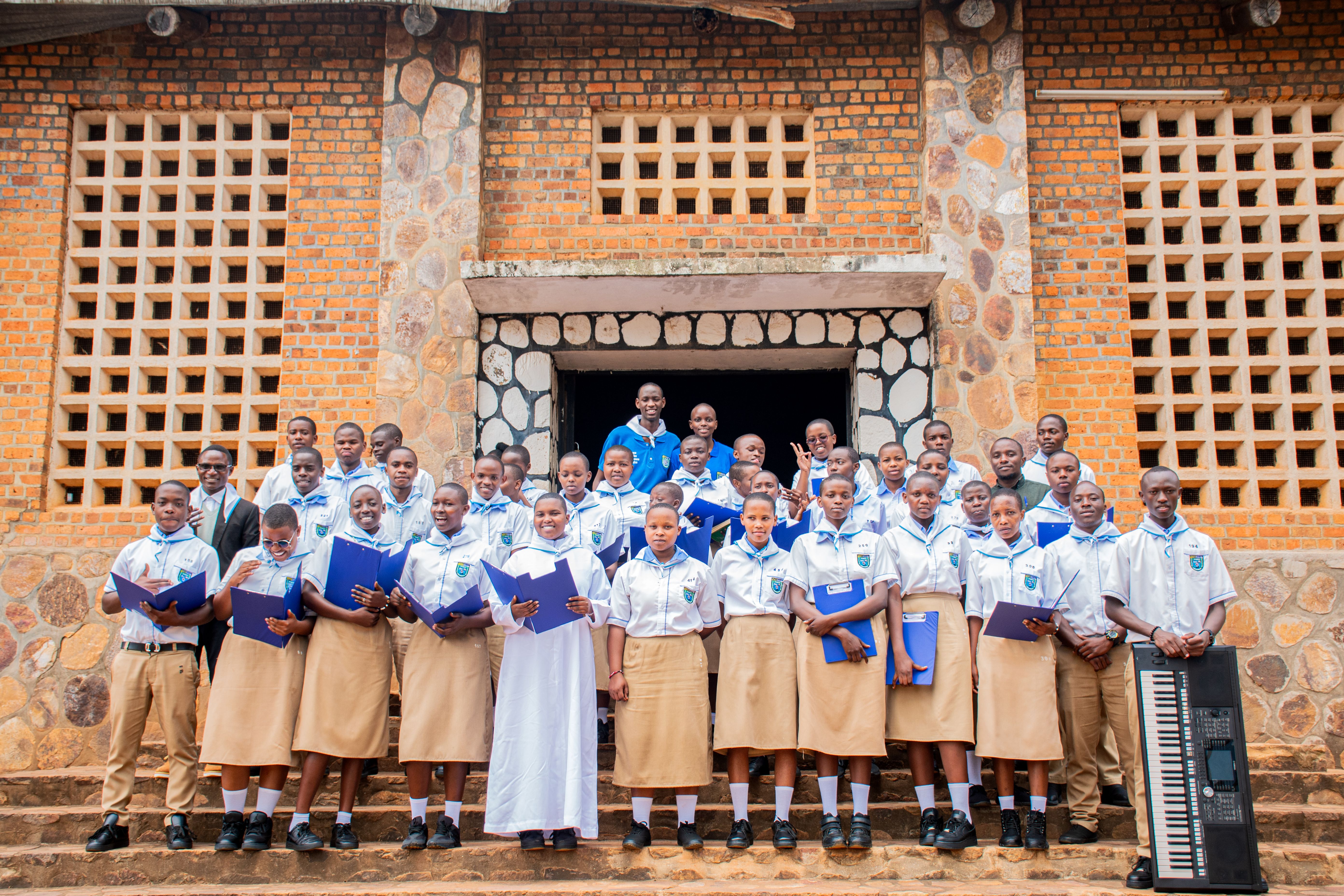 School Choir Group Photo at Brick Building · Free Stock Photo