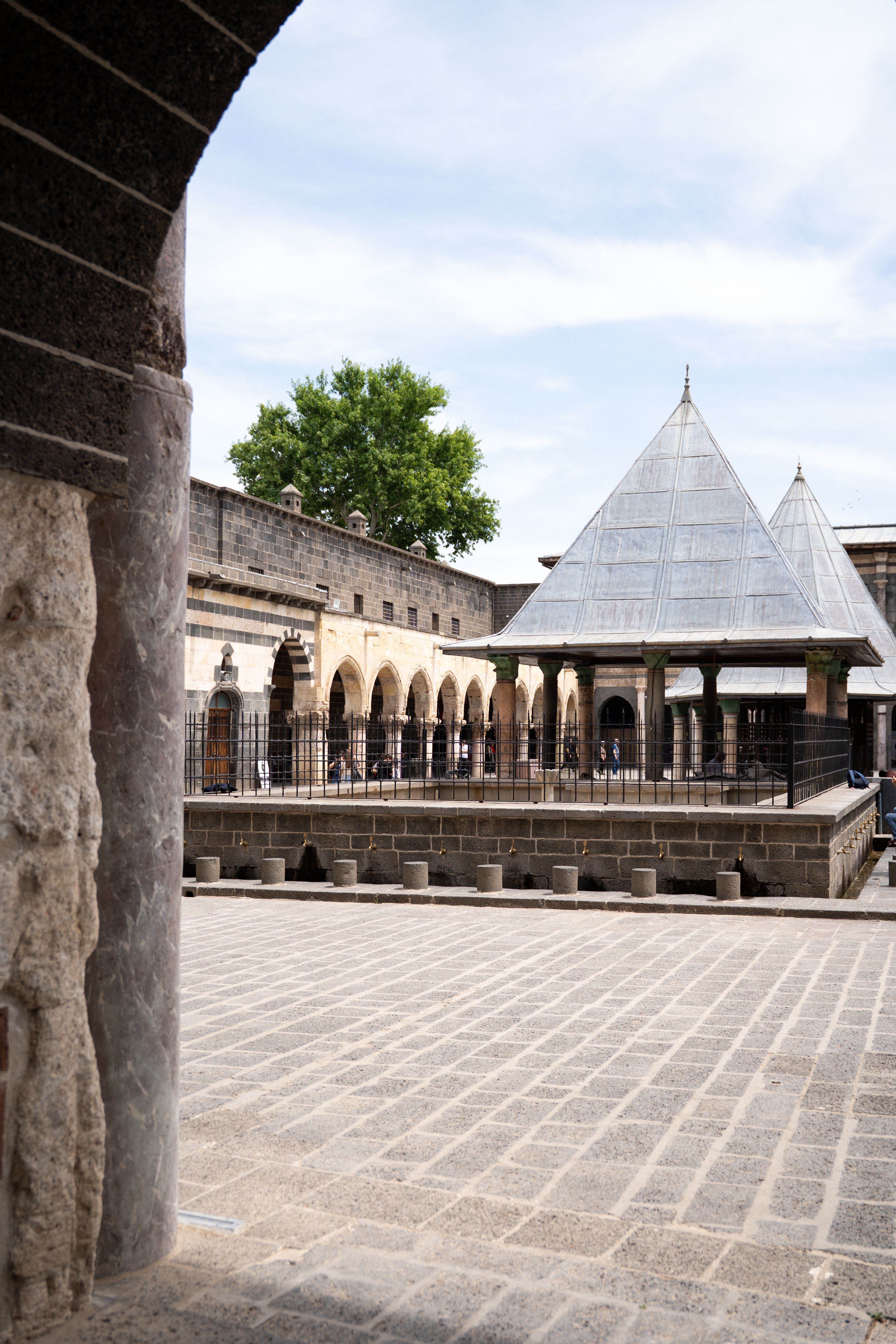 Historic Courtyard with Stone Archway and Pavilion · Free Stock Photo