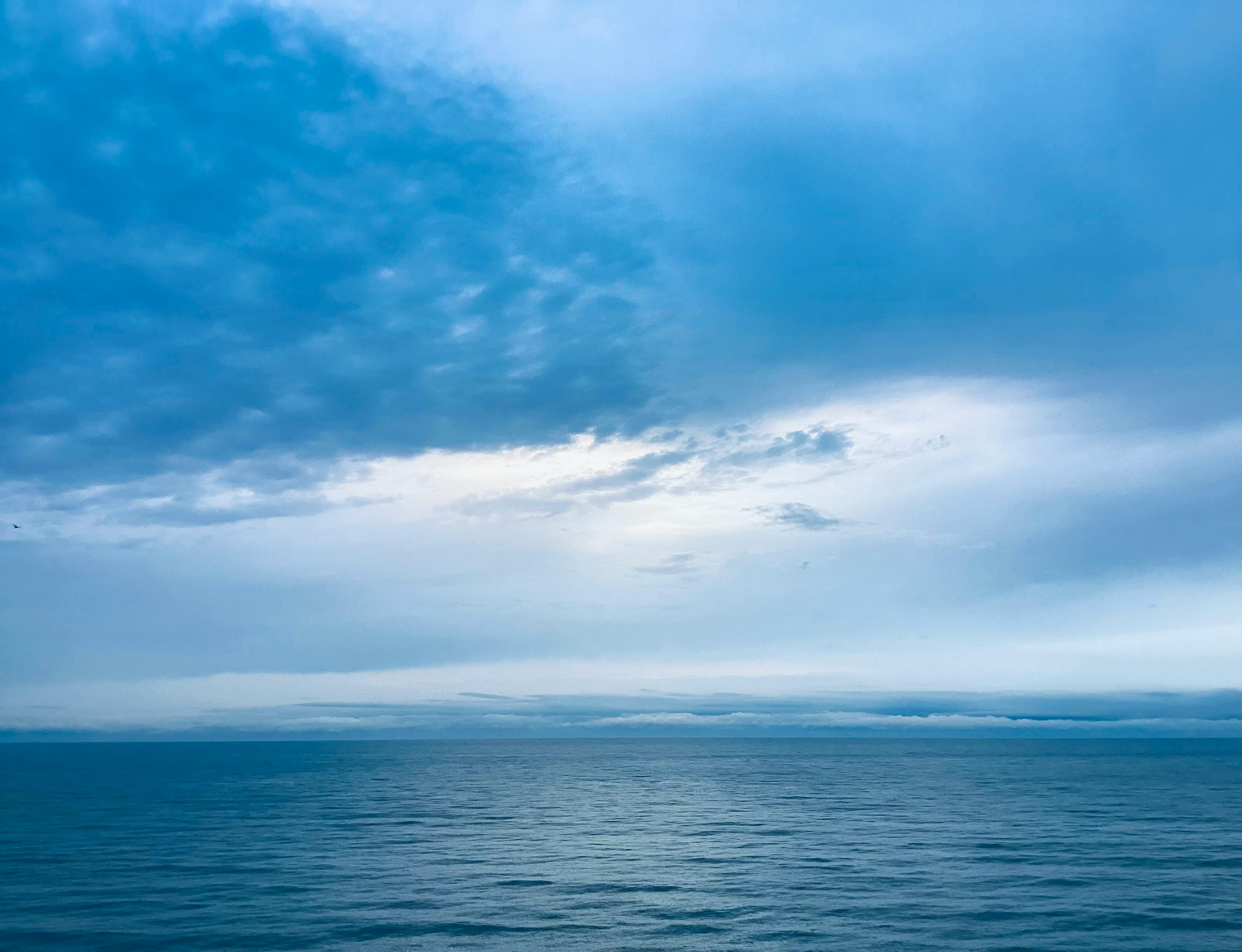 Serene Ocean Under Blue Sky at Daytime · Free Stock Photo