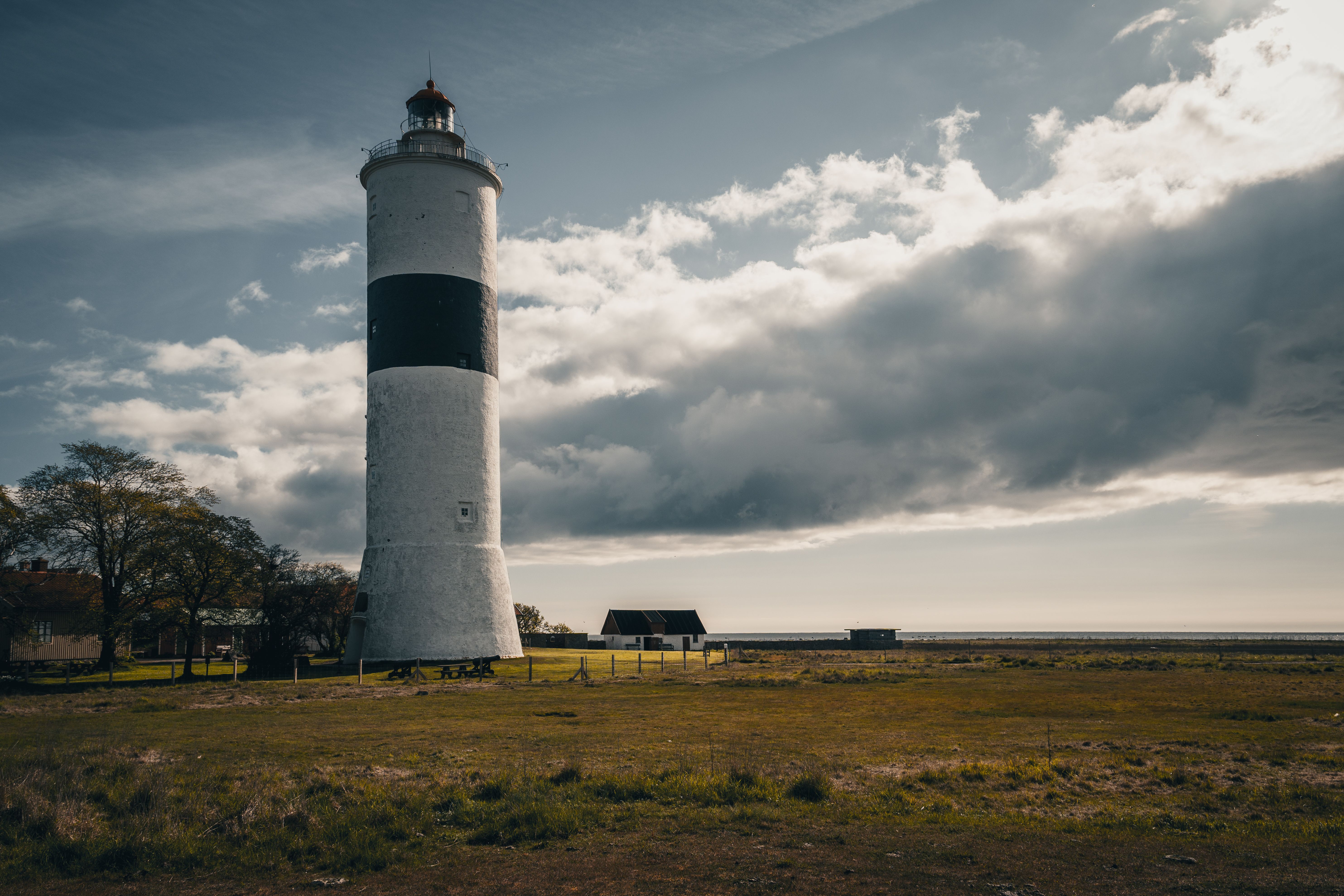 Scenic Lighthouse Against Dramatic Sky · Free Stock Photo