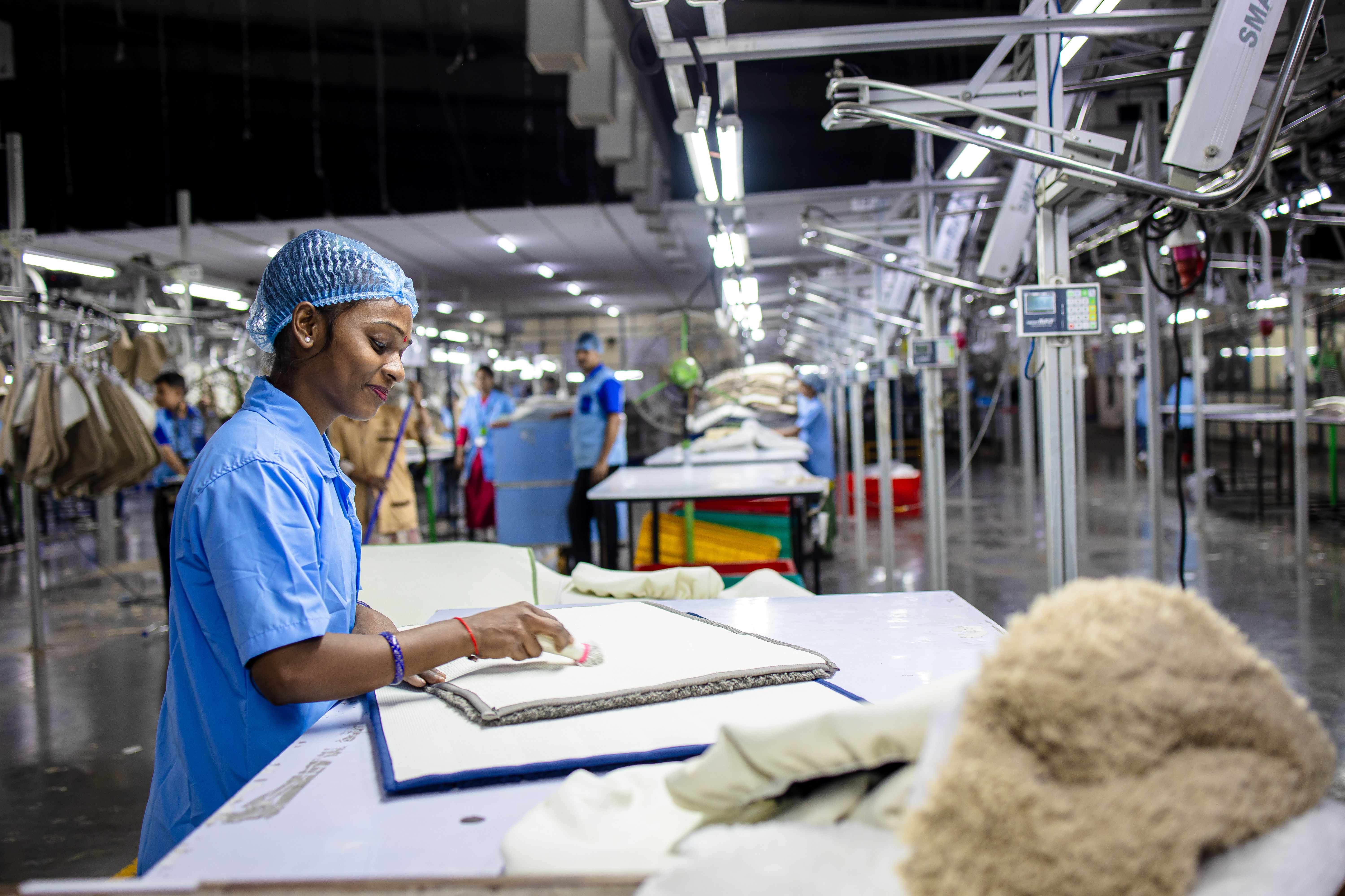 Textile Factory Worker Processing Fabrics · Free Stock Photo