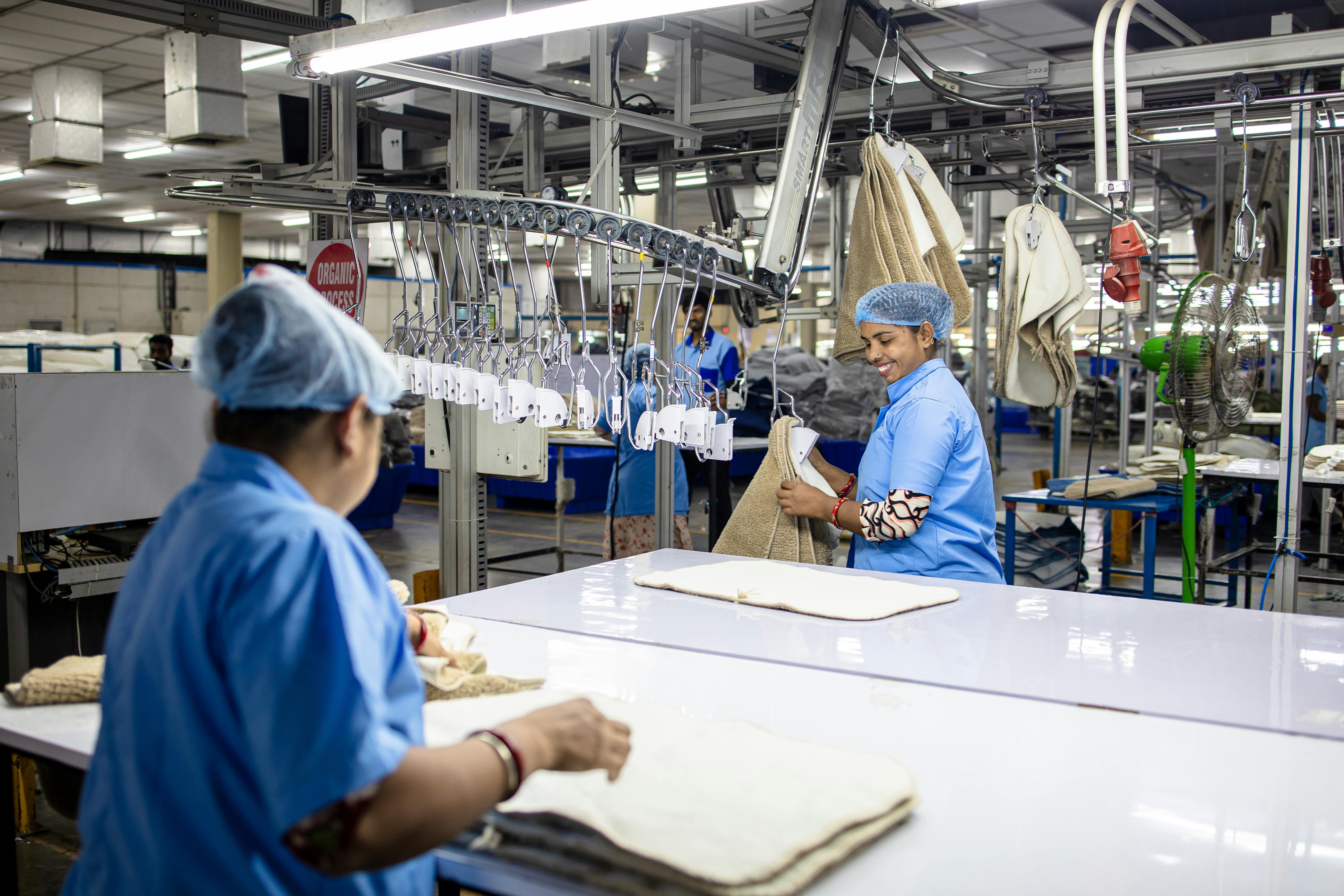 Textile Factory Workers Processing Fabrics · Free Stock Photo