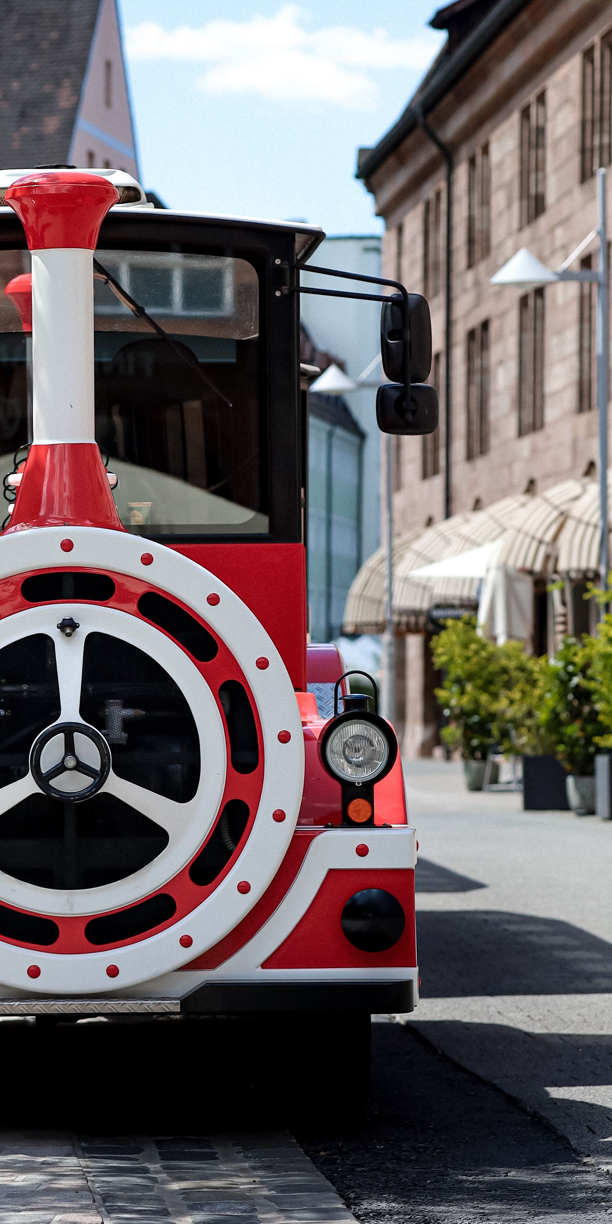 Red Tour Train on Cobblestone Street in Nuremberg · Free Stock Photo