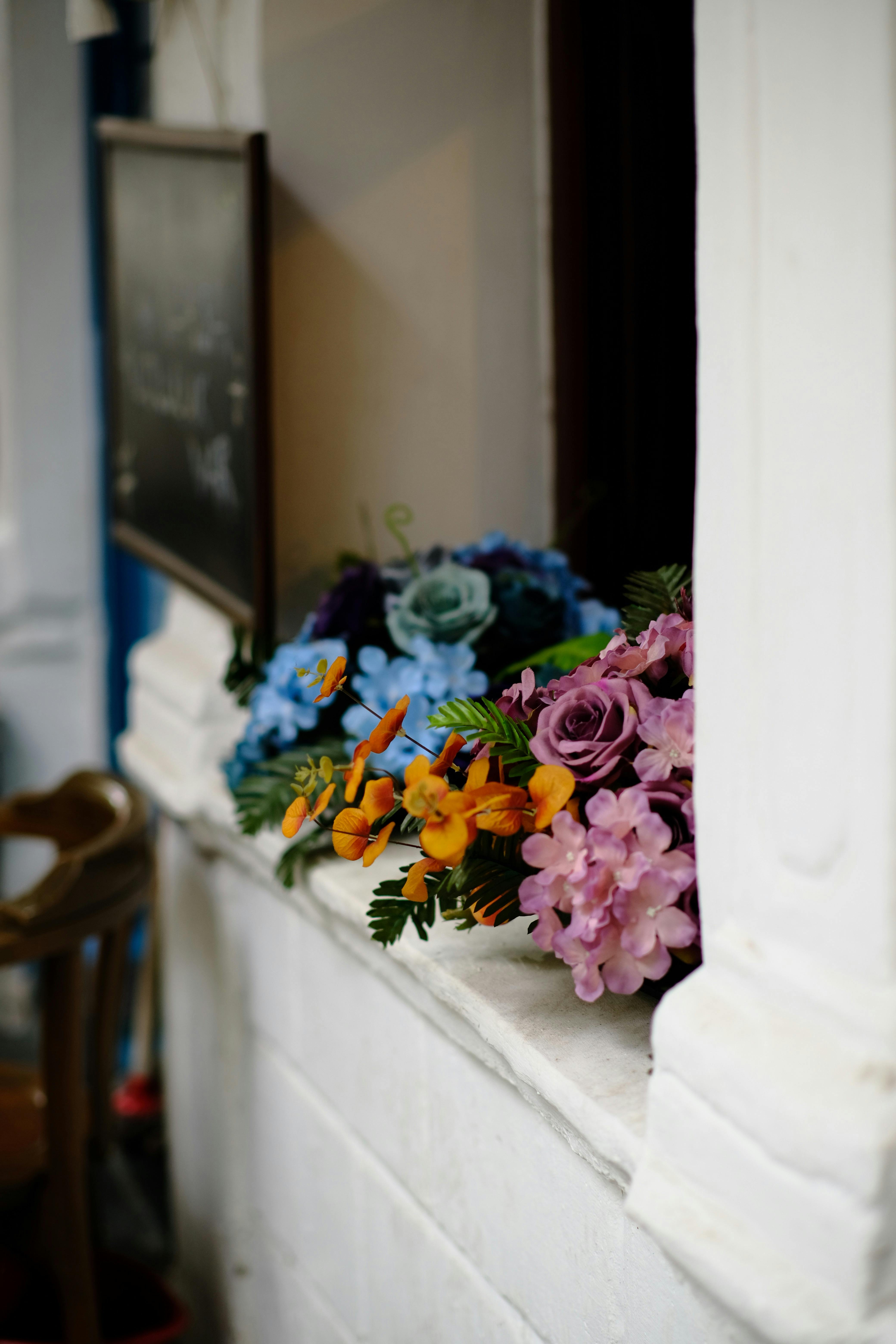 Vibrant Floral Arrangement on Mediterranean Window Sill · Free Stock Photo