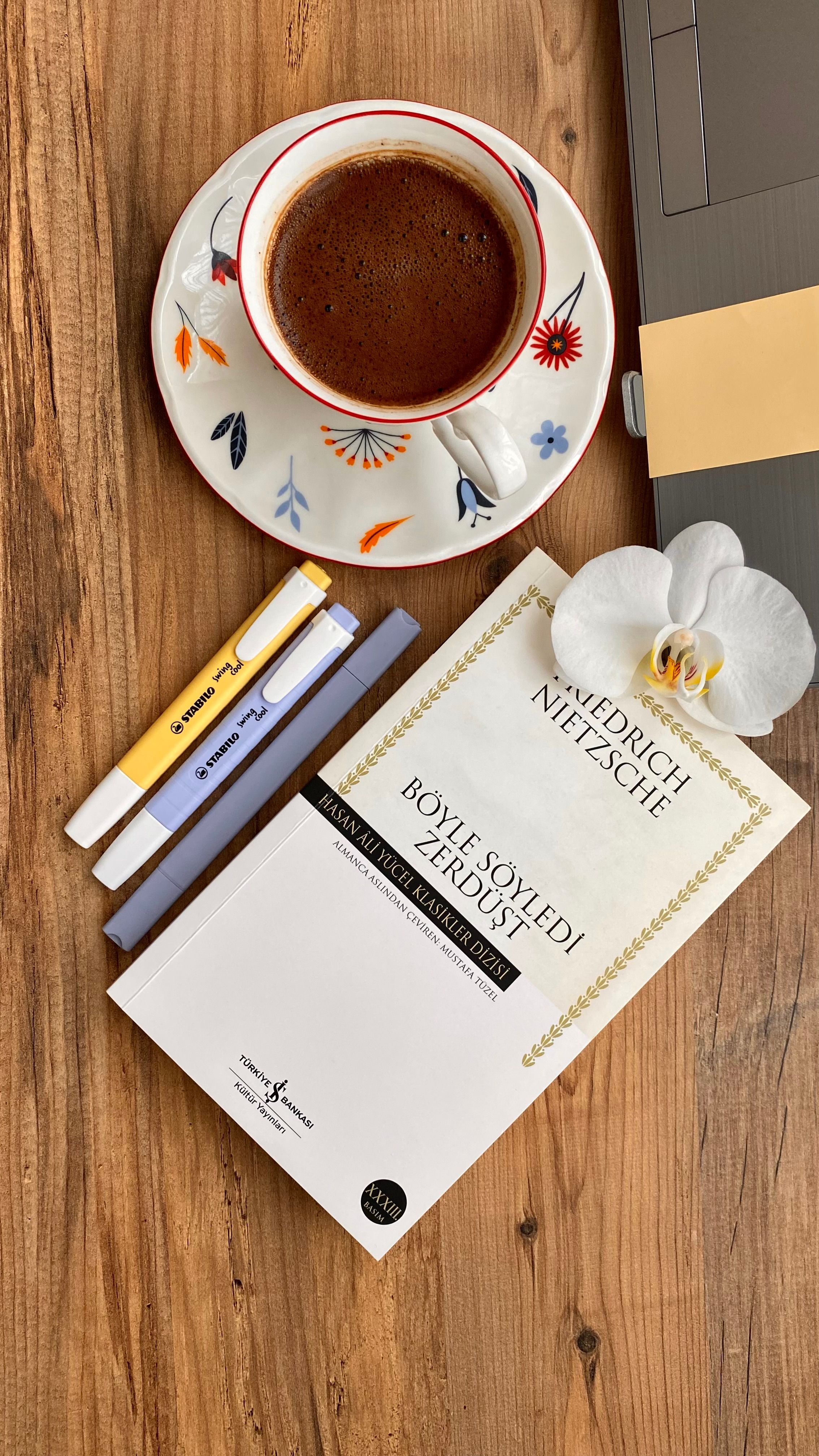 Cozy Coffee Break with Nietzsche's Book on Wooden Table · Free Stock Photo