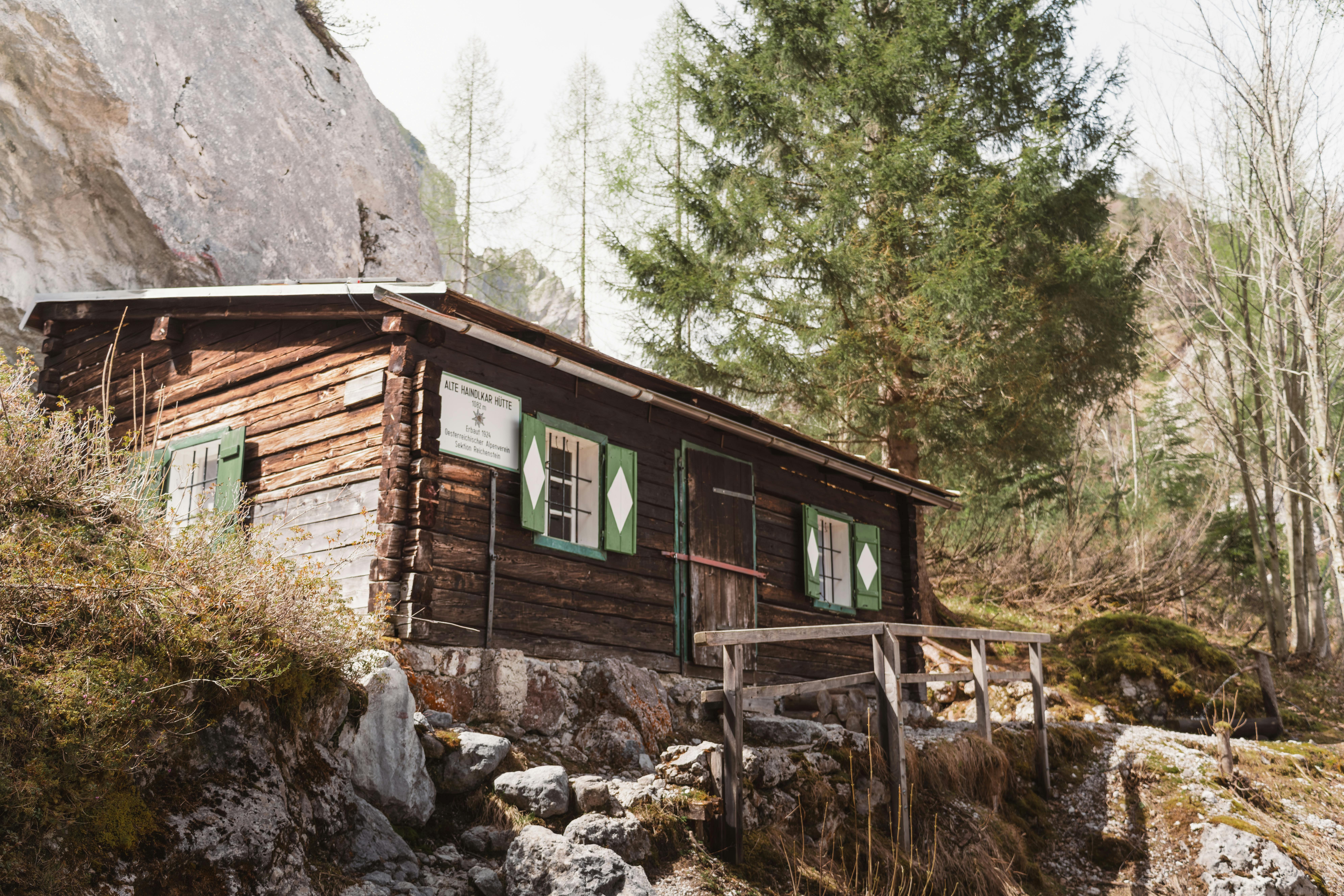 Rustic Mountain Cabin Nestled in Alpine Forest · Free Stock Photo