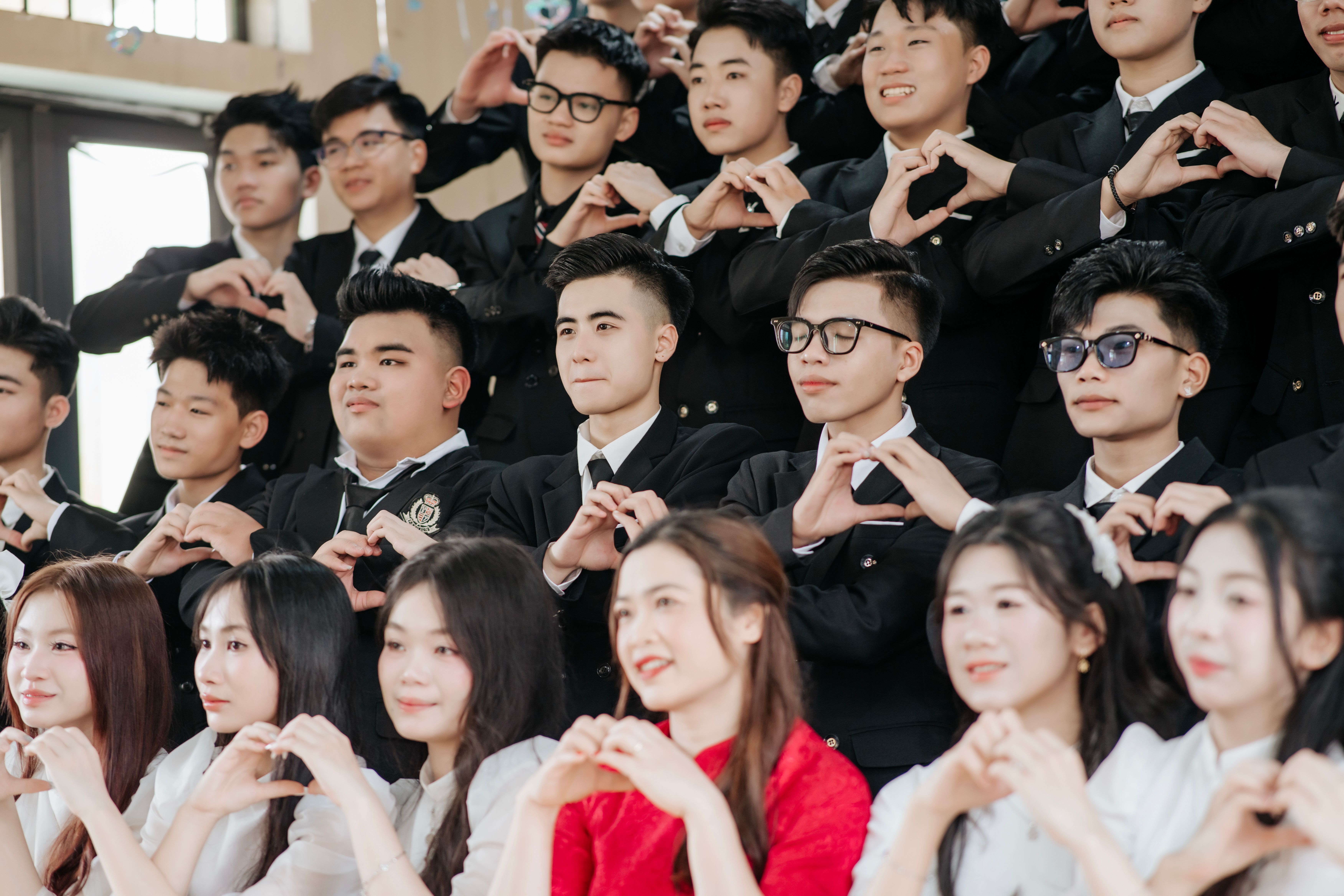 Group of Students in Traditional Attire Celebrating · Free Stock Photo