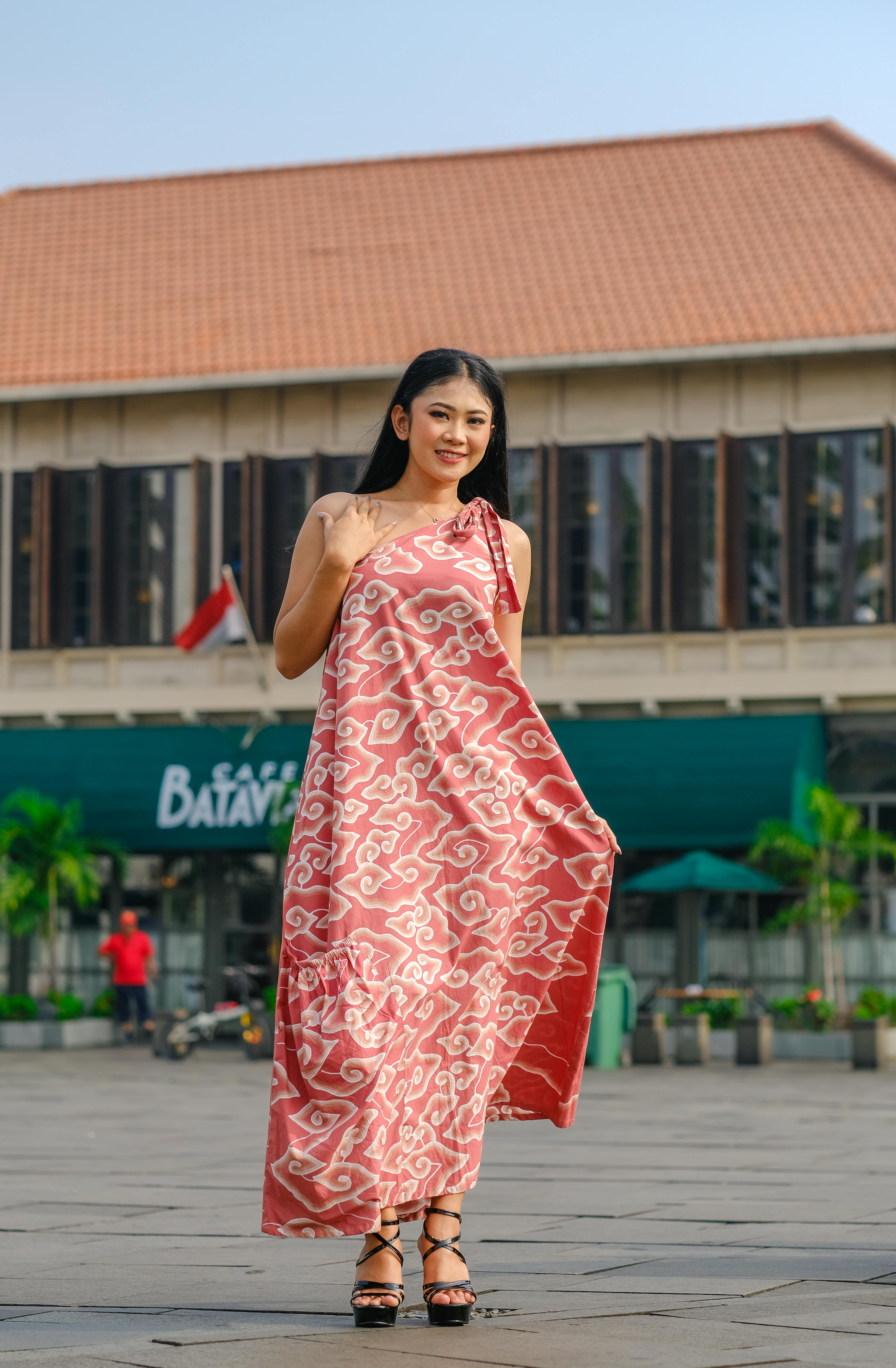 Elegant Woman in Batik Dress at Café Batavia · Free Stock Photo