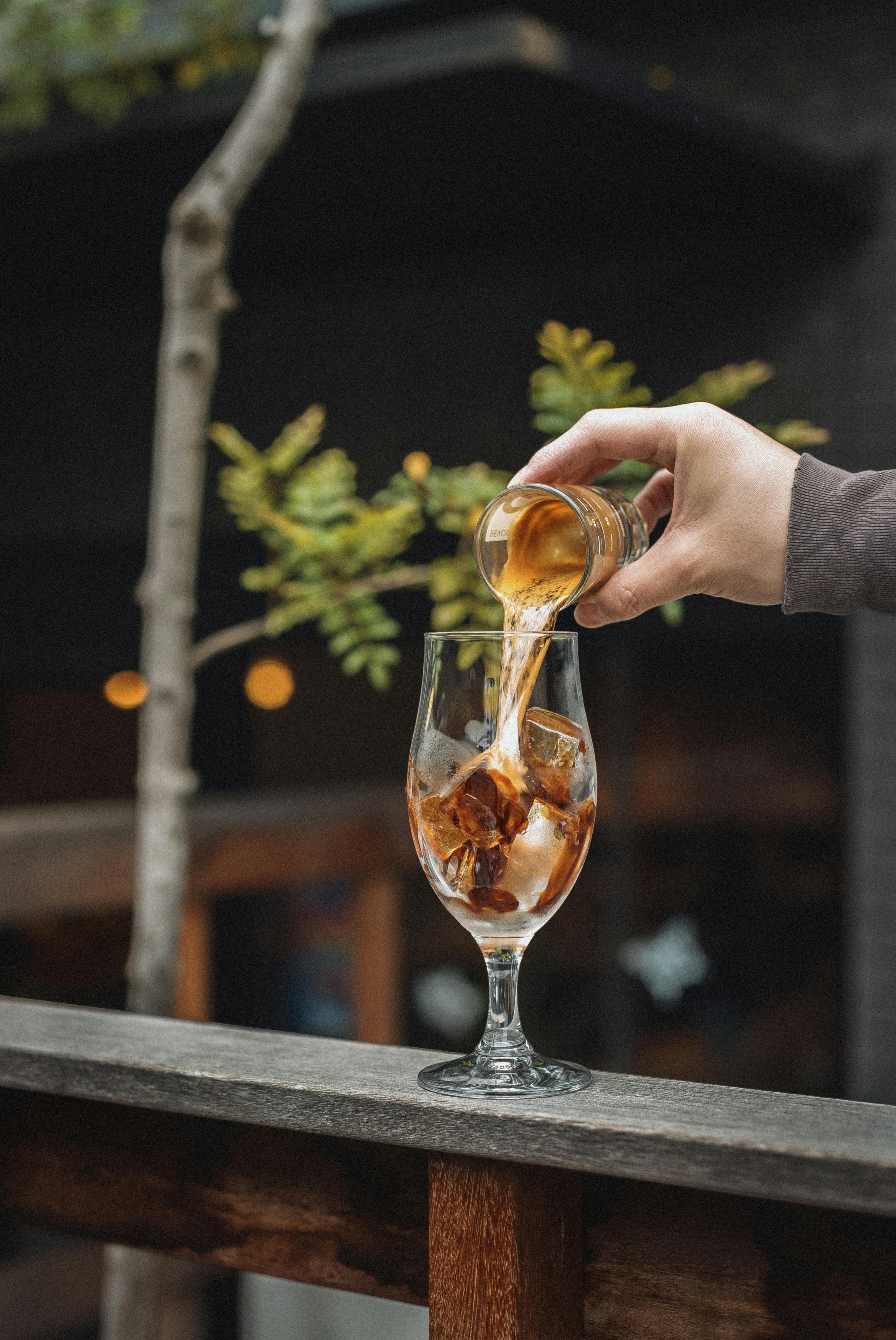 Pouring Iced Coffee at a Tokyo Café Terrace · Free Stock Photo