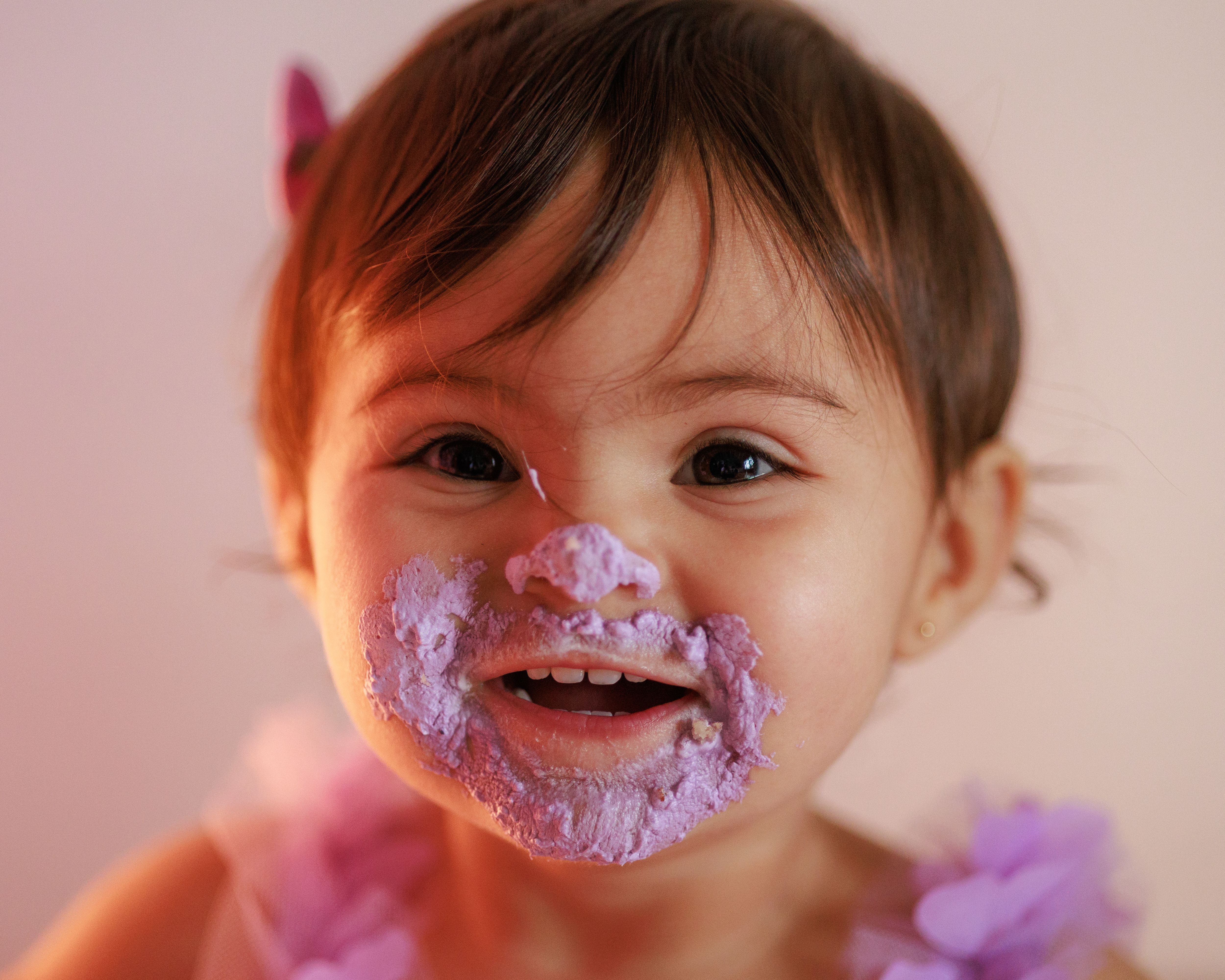 Adorable Baby with Frosting on Face Smiling Brightly · Free Stock Photo