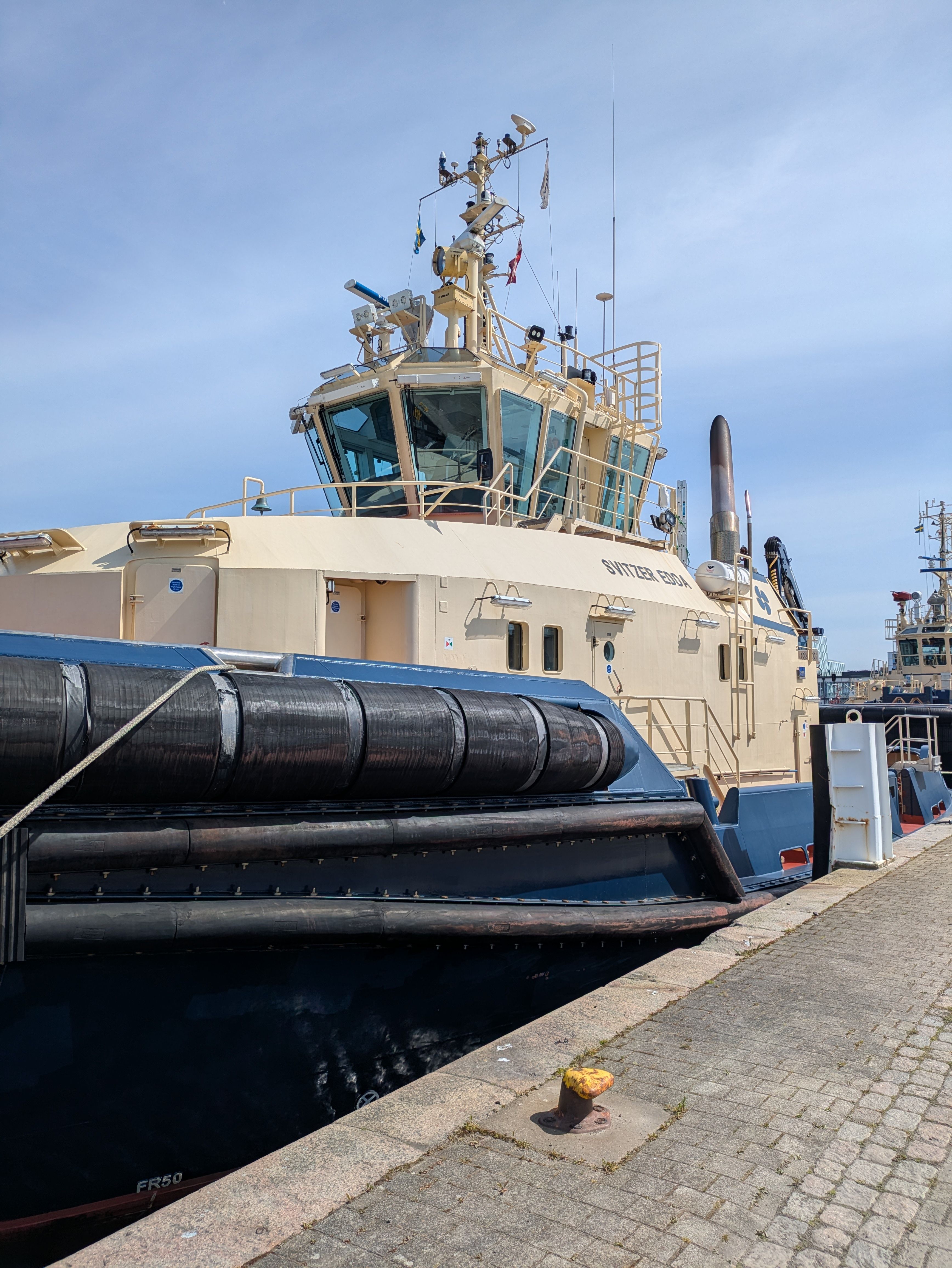 Powerful Tugboat Docked at Harbor Front View · Free Stock Photo