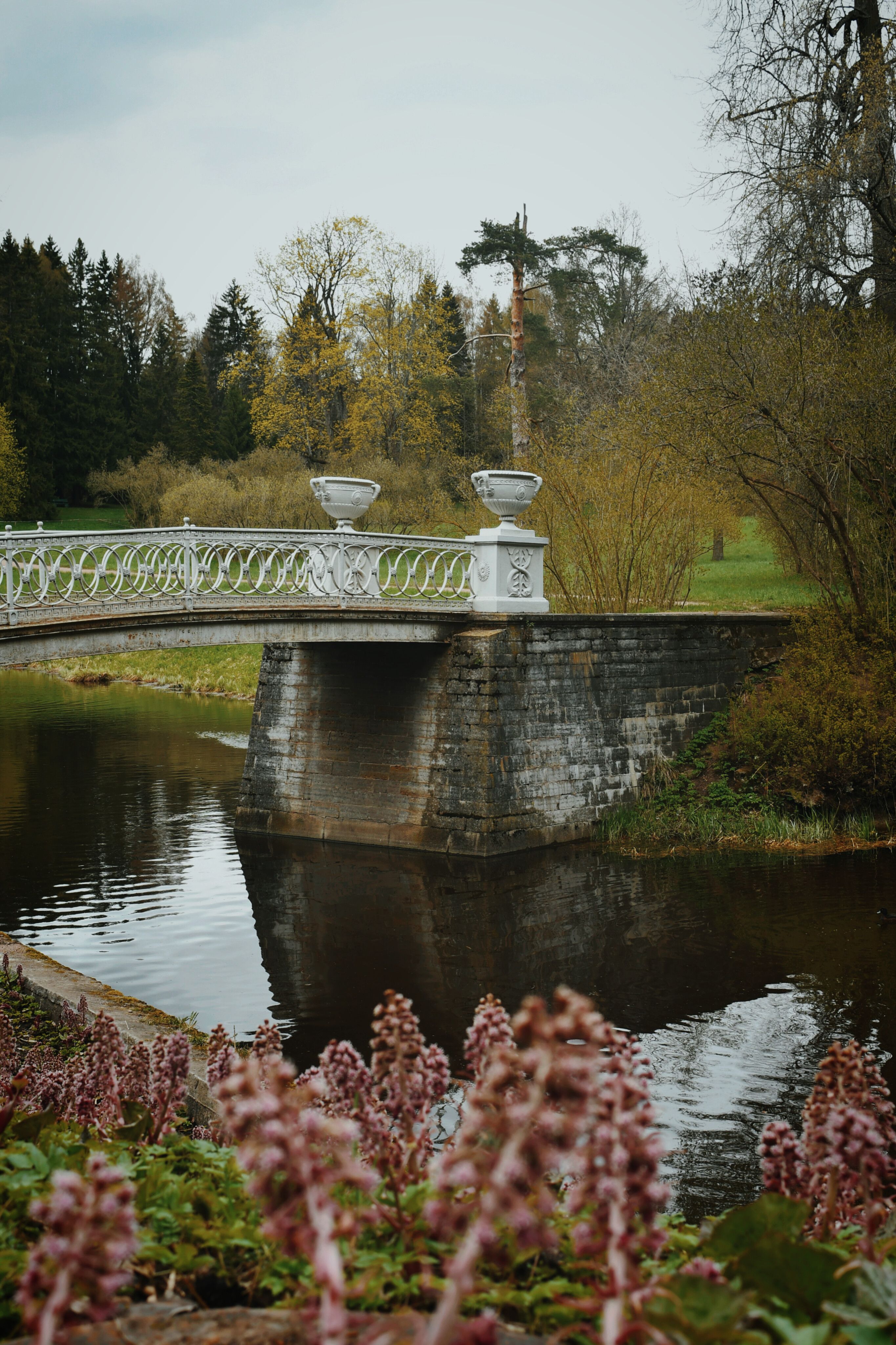 Elegant Stone Bridge Over Serene Garden Pond · Free Stock Photo