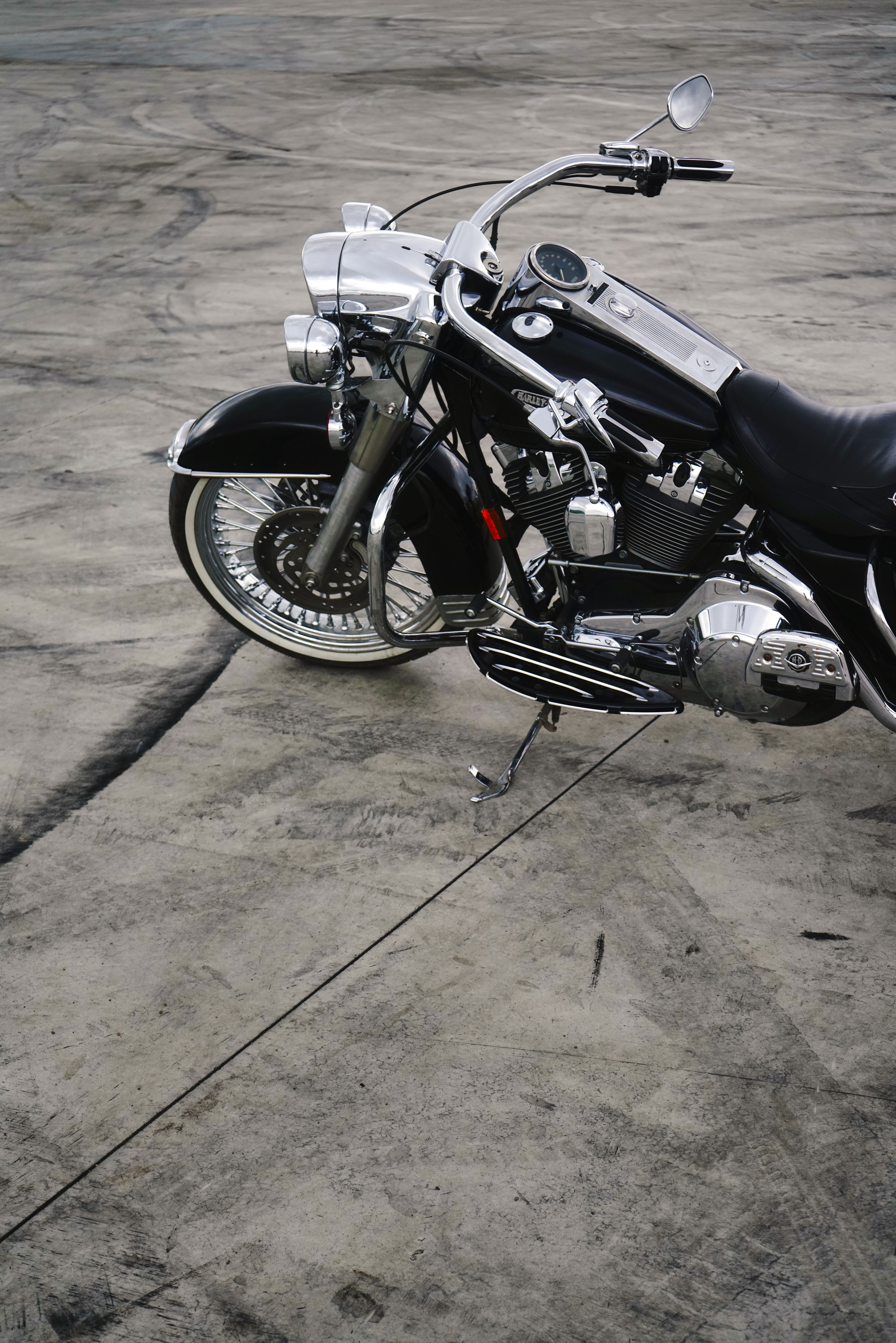 Classic Motorcycle Parked on Urban Pavement · Free Stock Photo