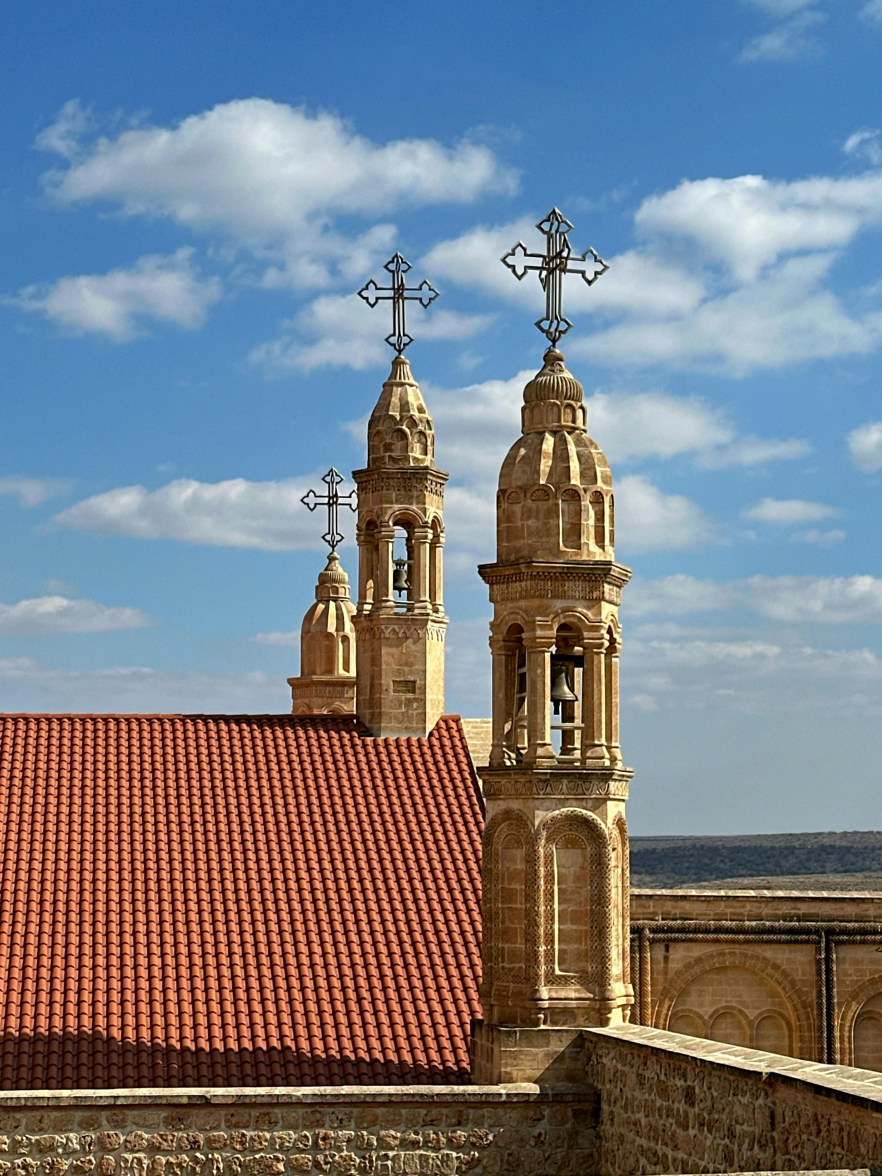Historic Monastery Bell Towers Under Blue Sky · Free Stock Photo