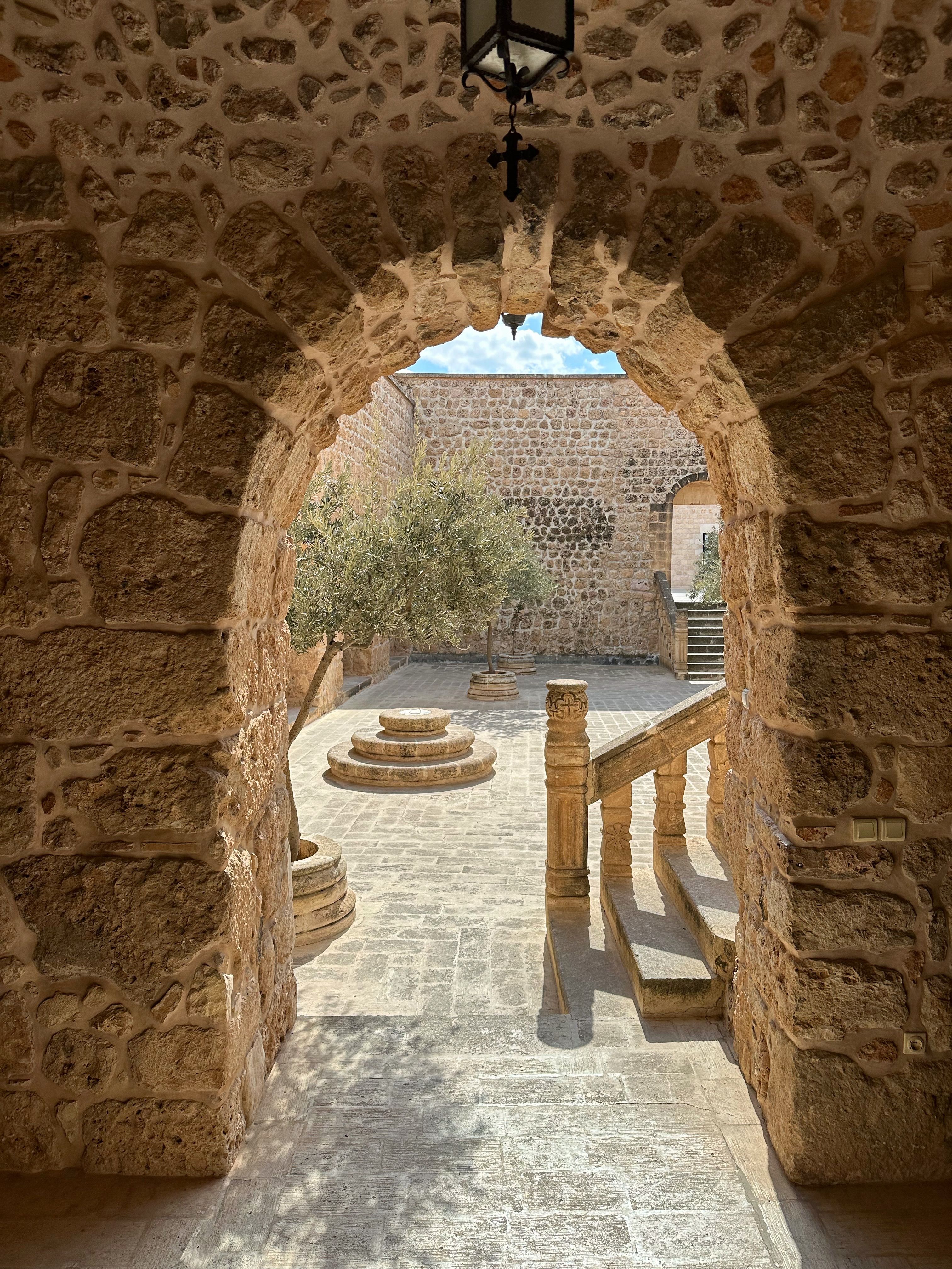 Ancient Stone Courtyard with Arched Entryway · Free Stock Photo