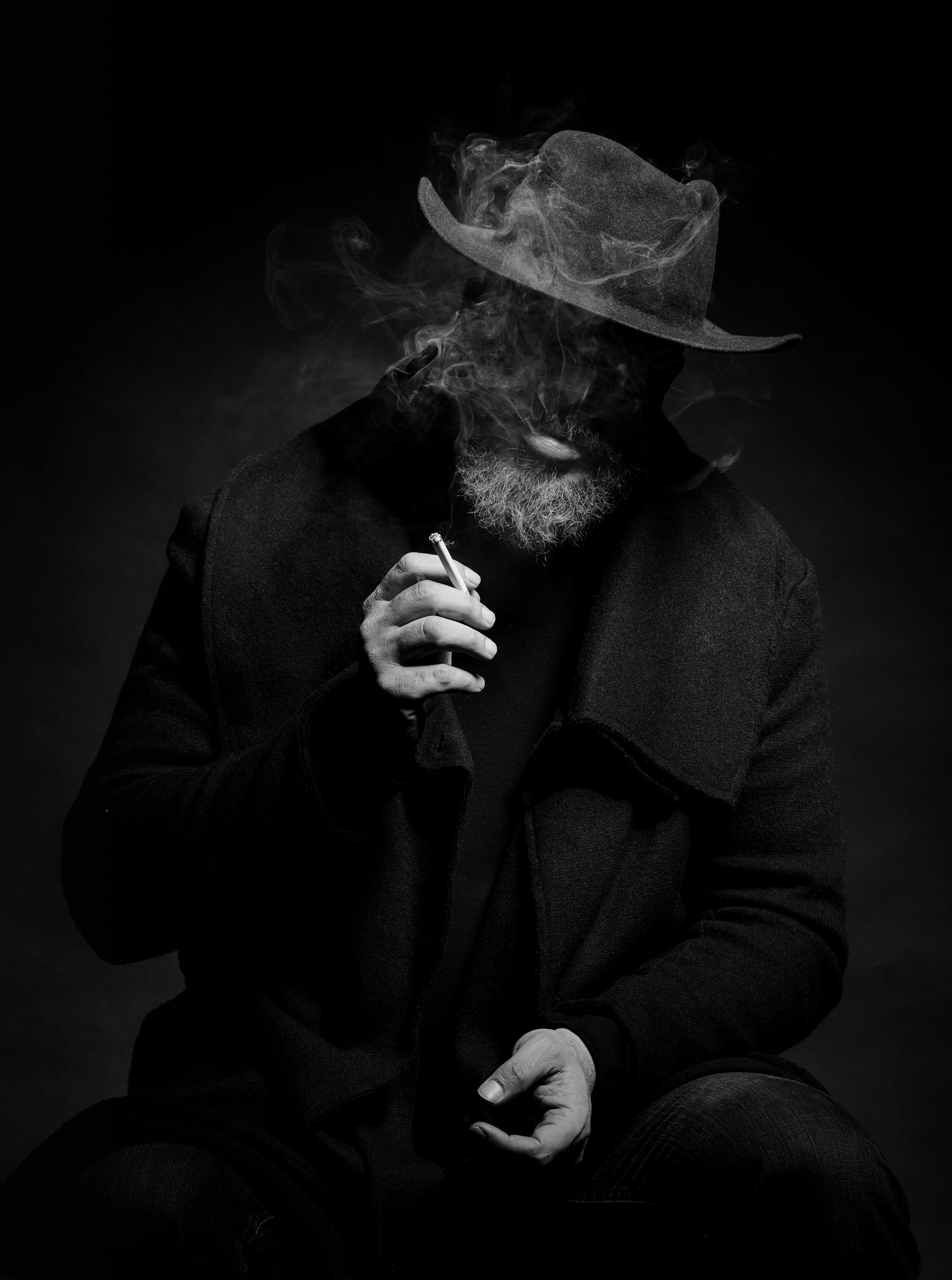 Moody Portrait of a Man Smoking in Black and White · Free Stock Photo